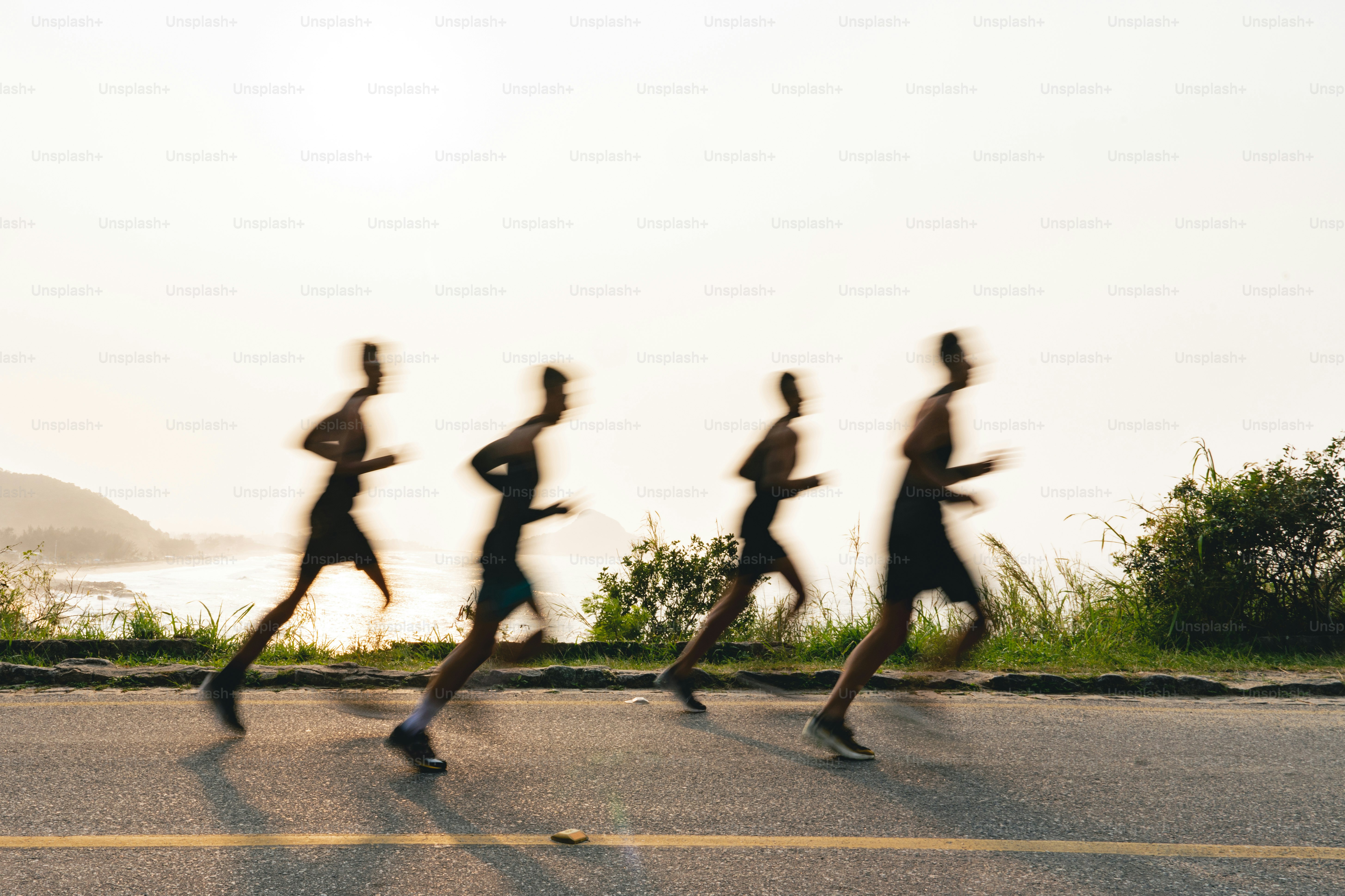 A group of people running down a street photo – Runners Image on Unsplash