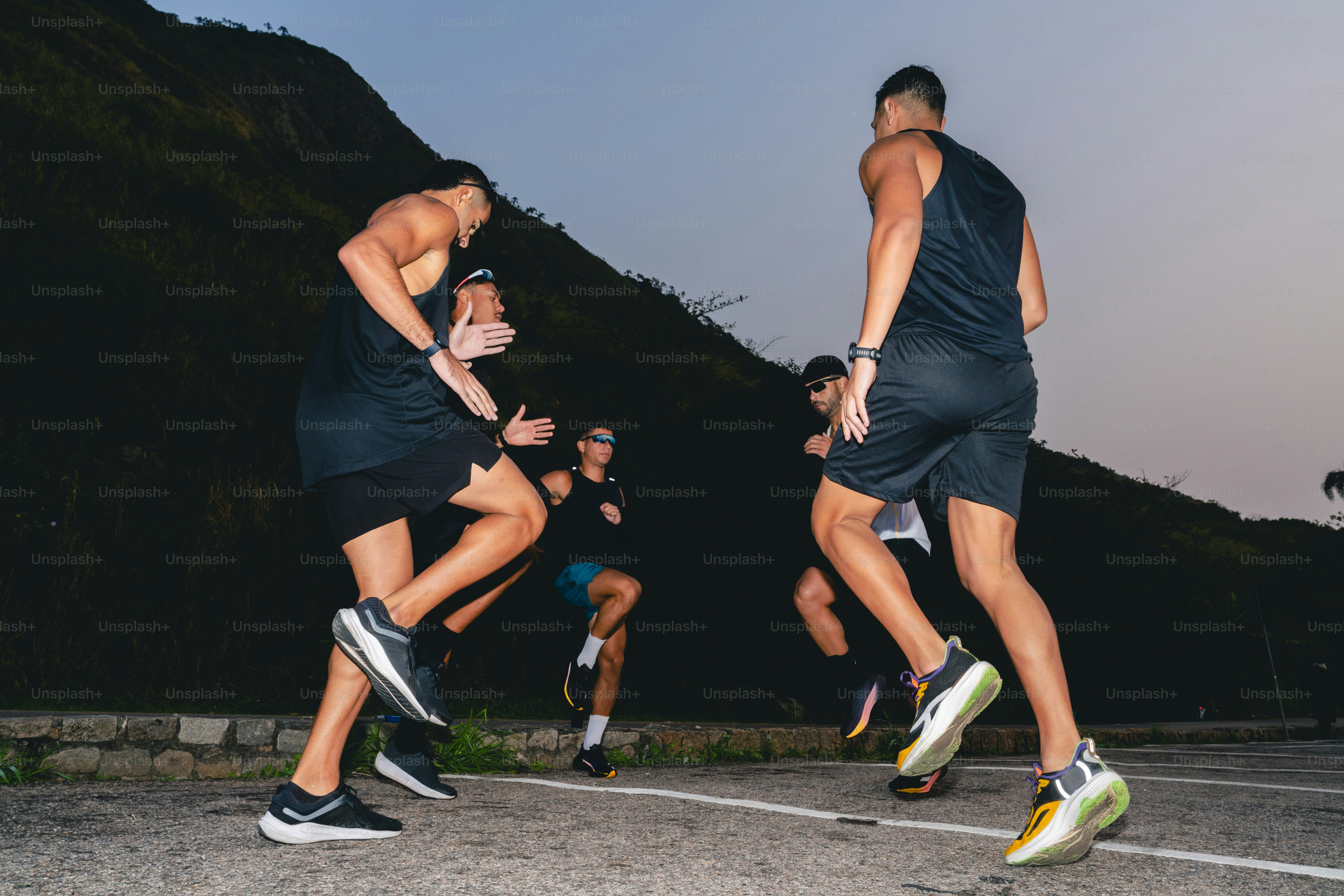 A group of people running down a road photo – Running Image on Unsplash