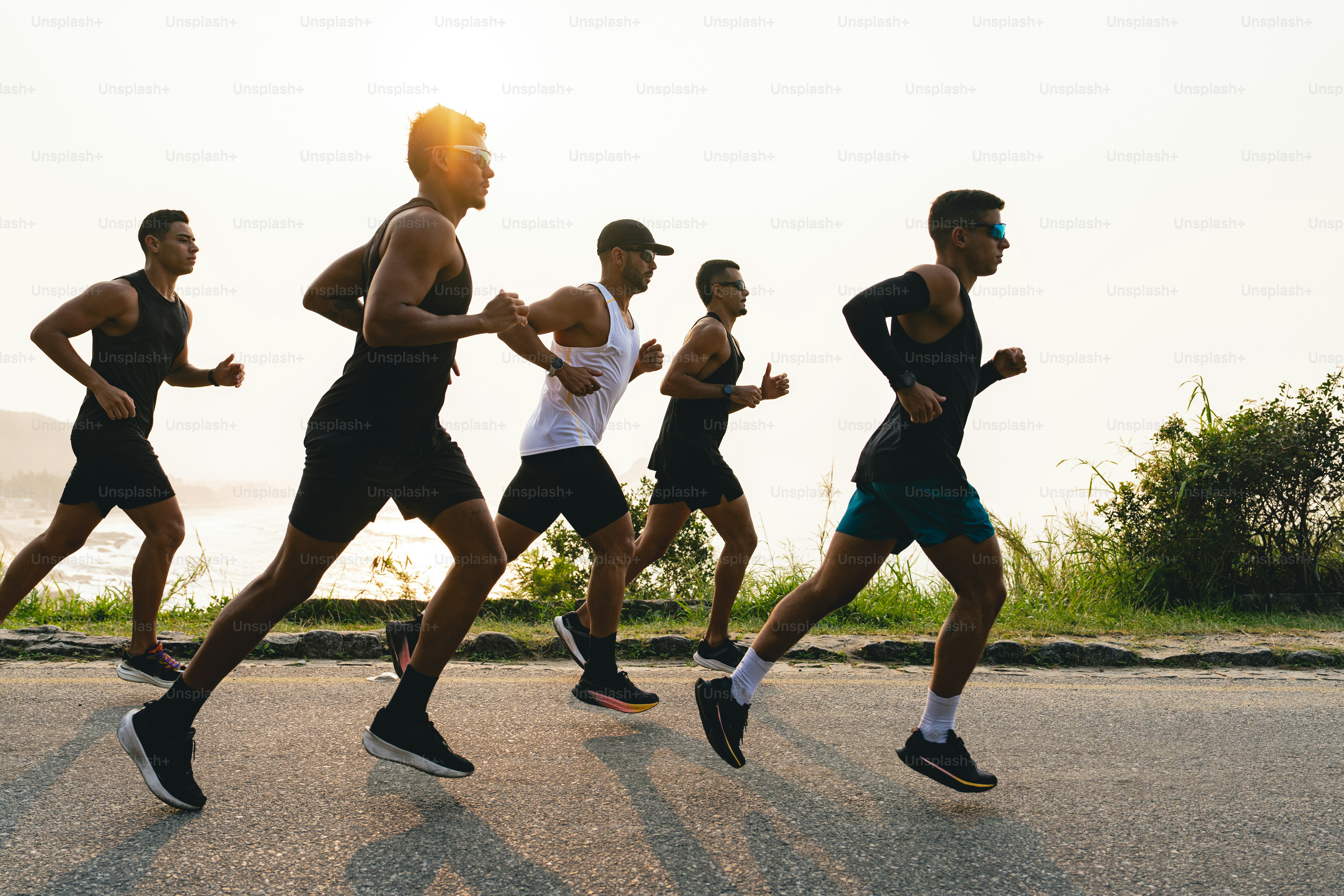 A group of people running down a street photo – Runners Image on Unsplash