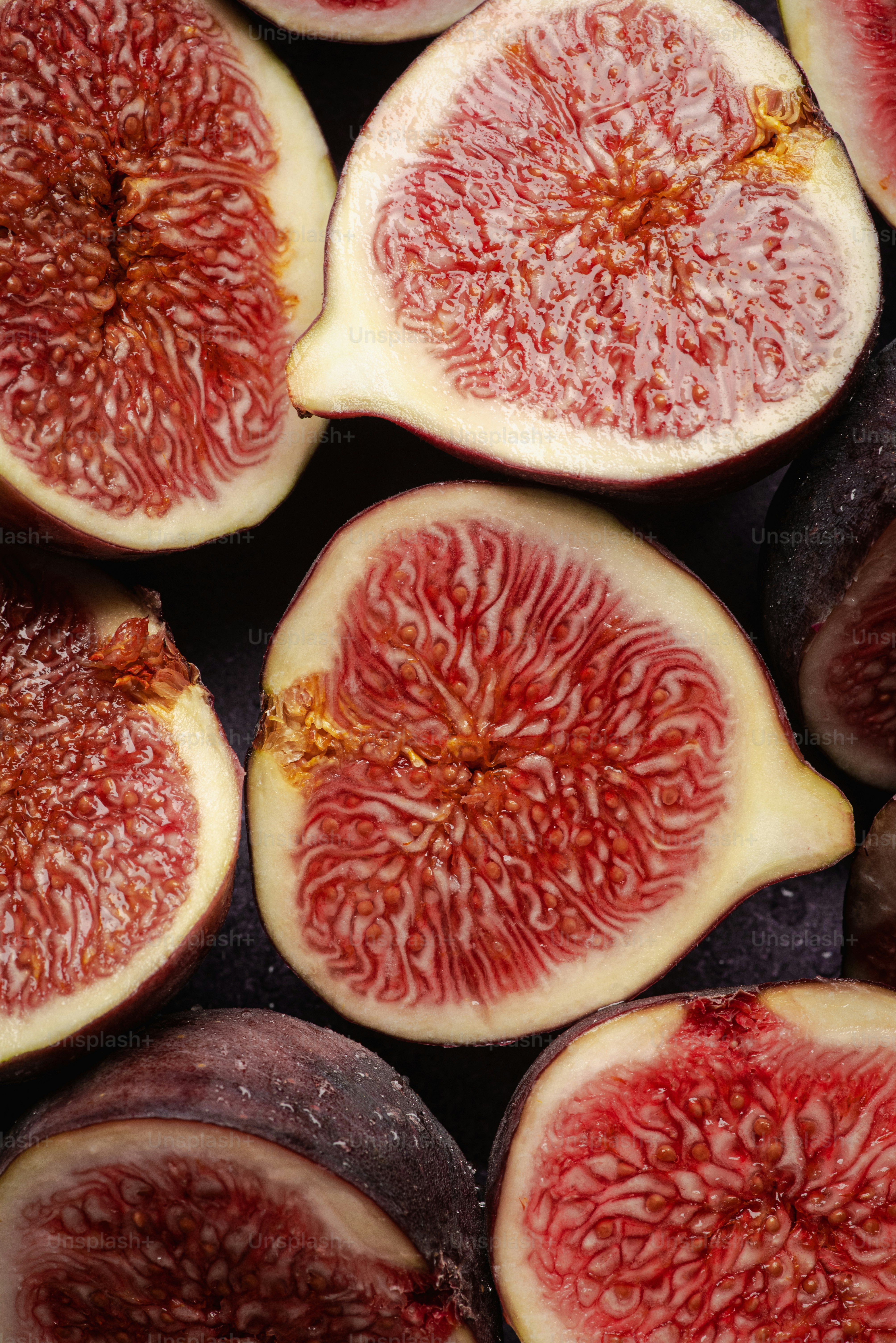 A close up of a bunch of figs cut in half photo – Texture Image on Unsplash