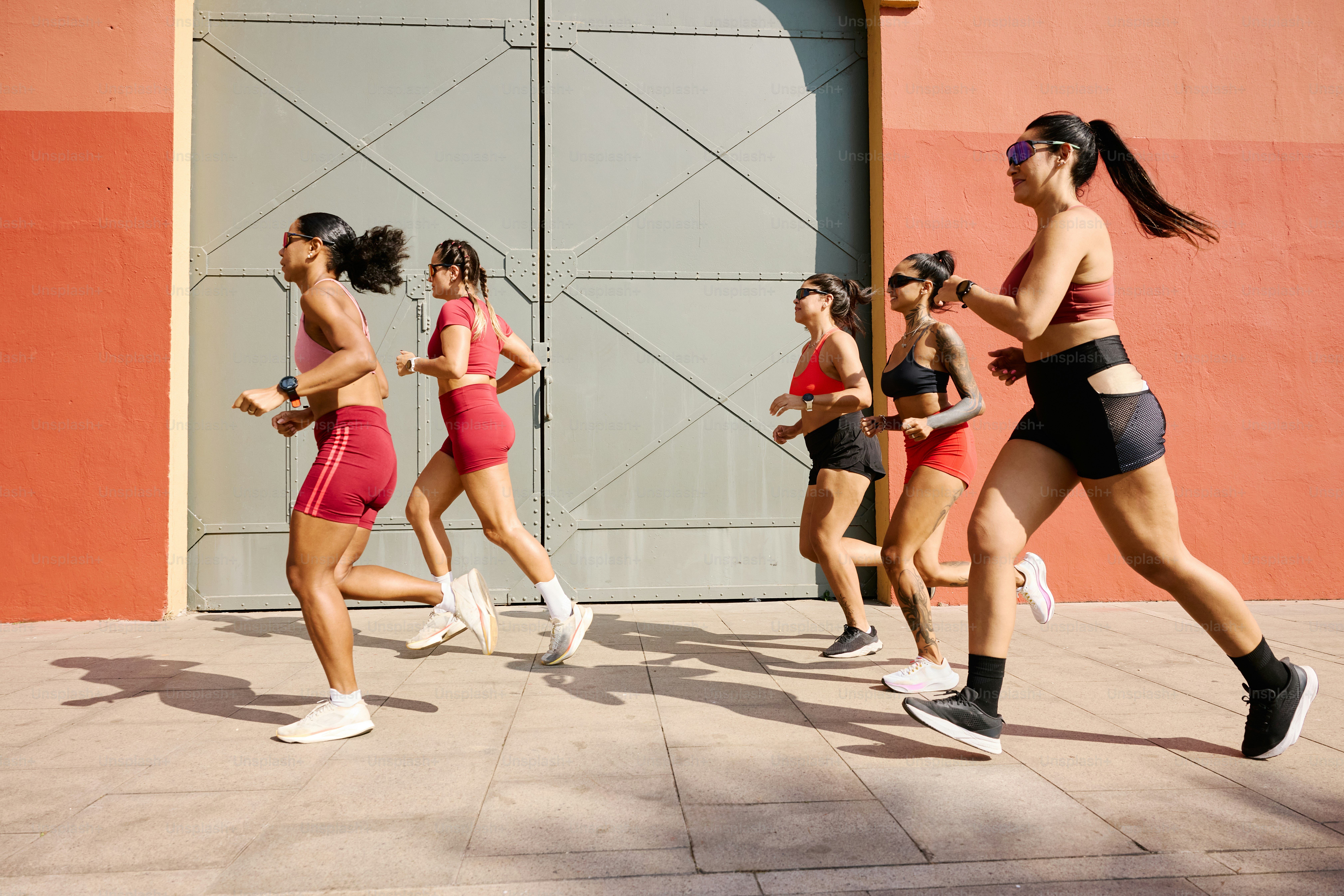 A group of women sitting on a bench in front of a building photo ...