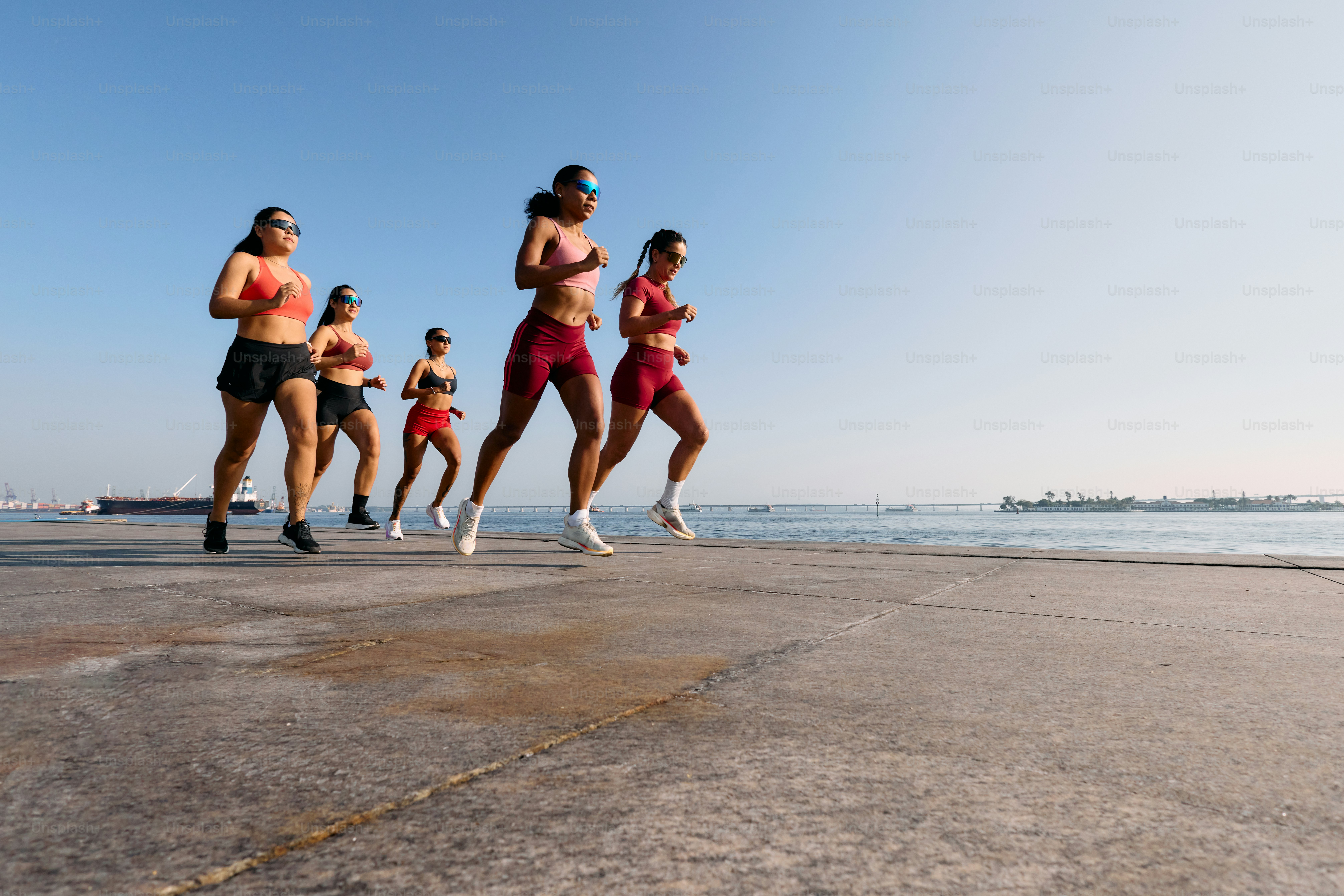 A group of women sitting on a bench in front of a building photo ...