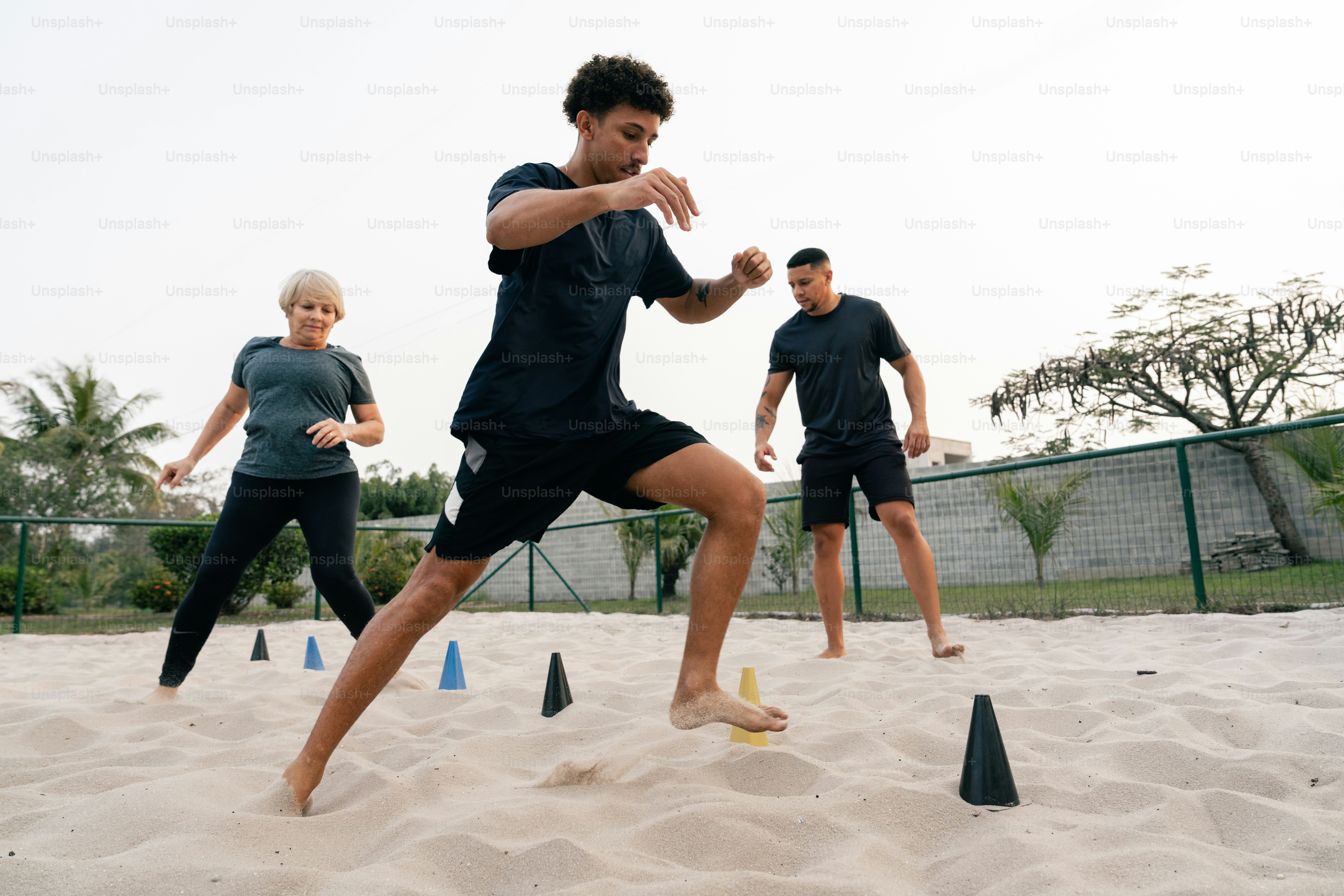 A group of young men playing a game of frisbee photo – Fitness Image on ...
