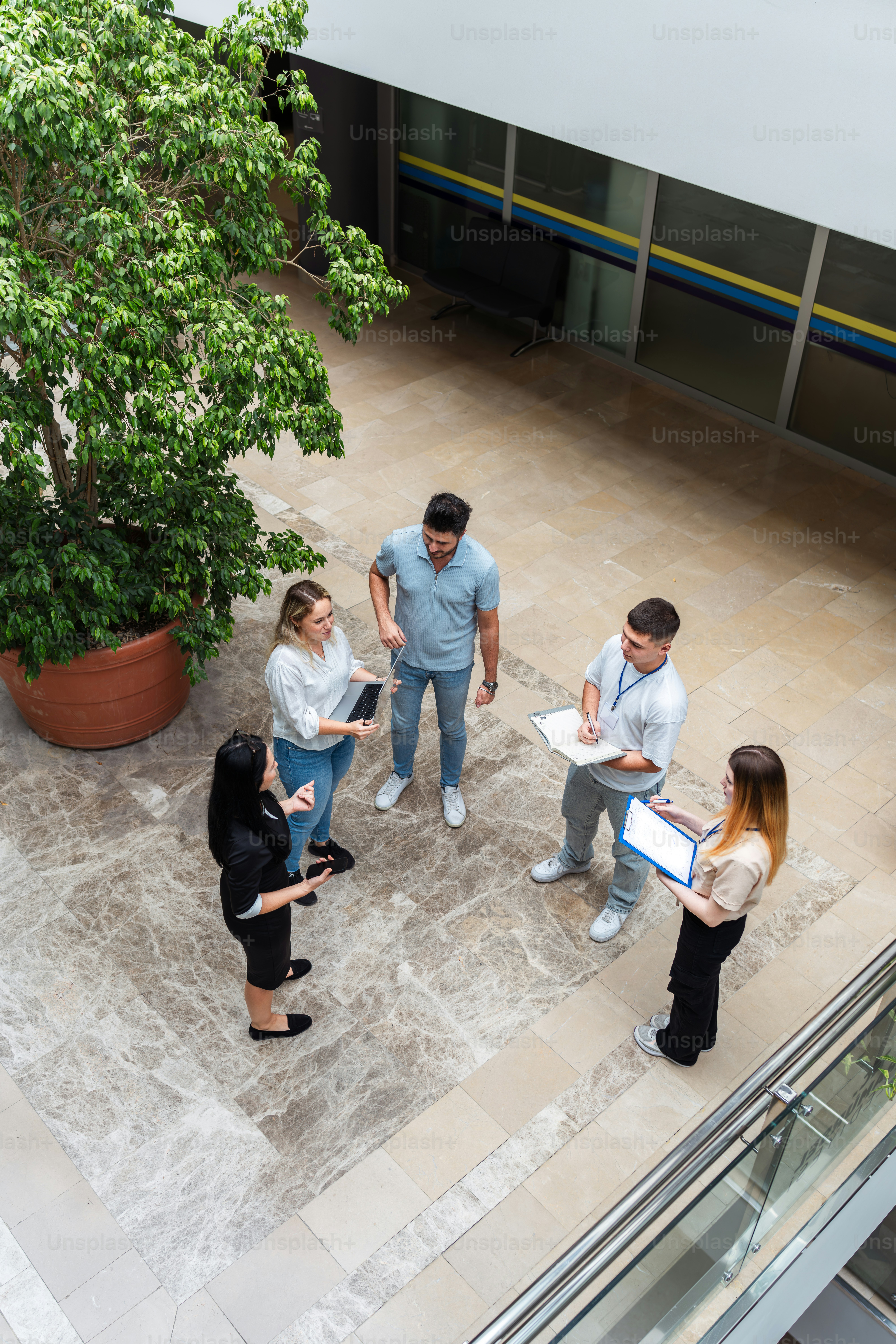 A group of people standing around a building photo – Mentoring Image on ...