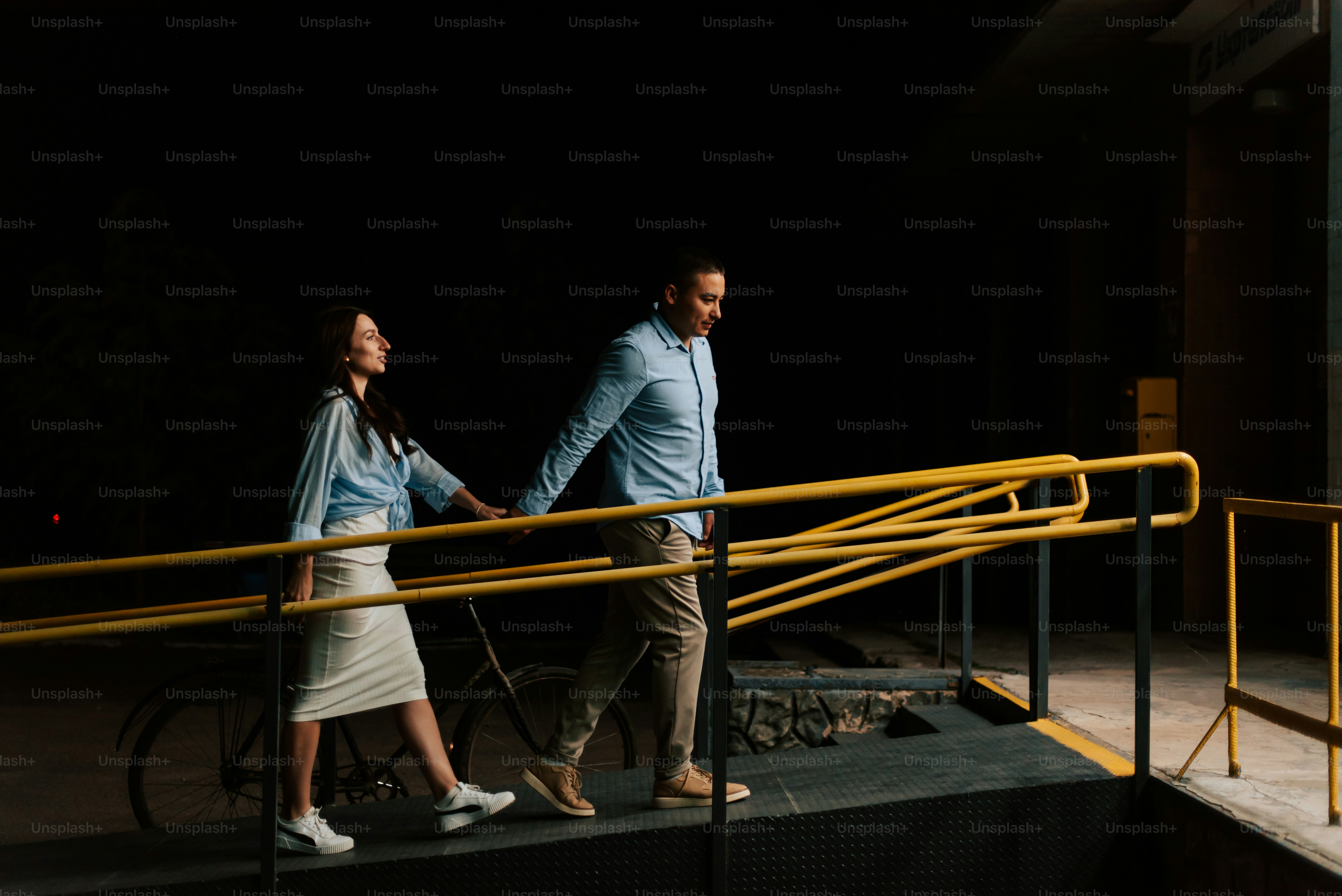A man and a woman walking down a ramp photo – Couple Image on Unsplash