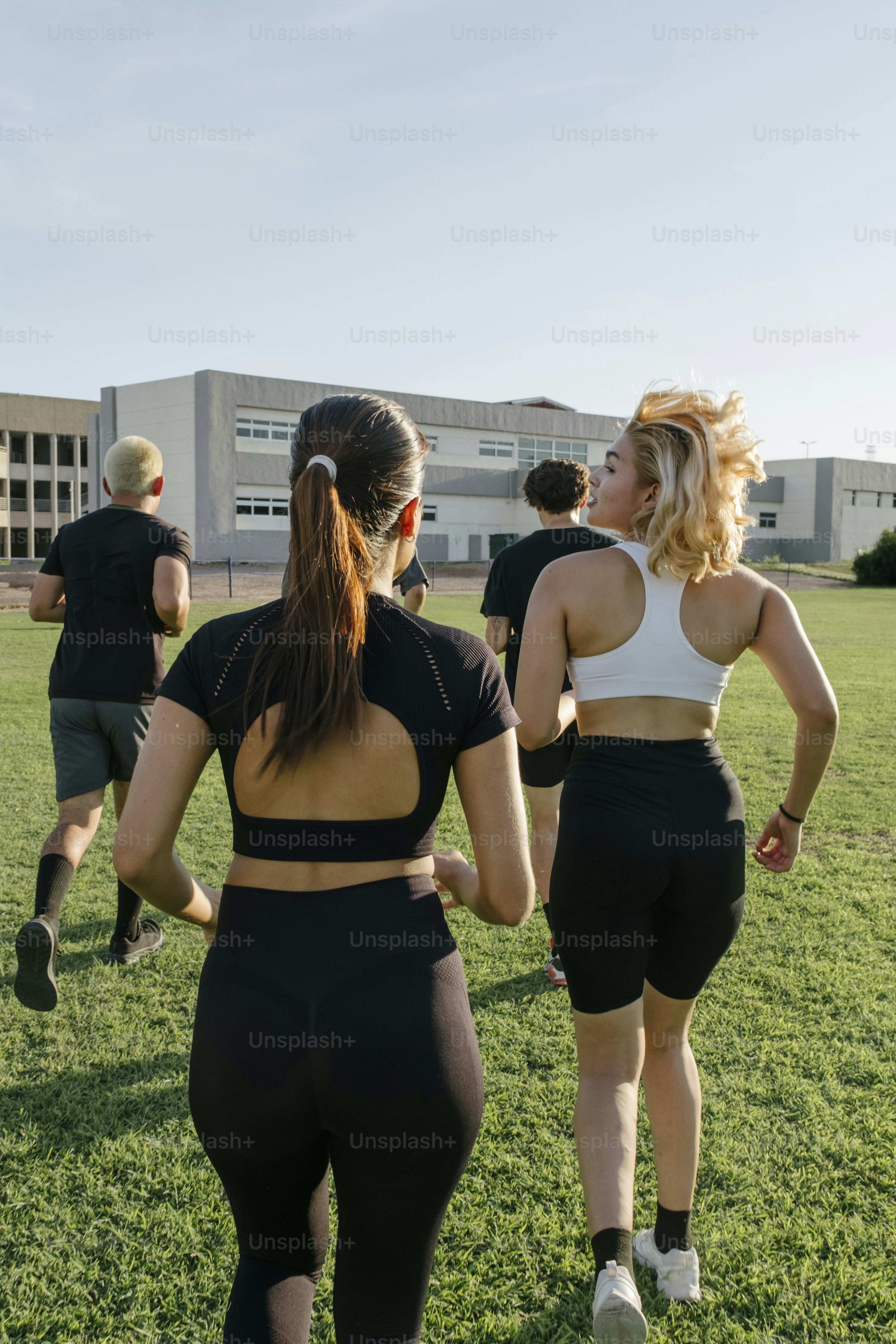 A group of women running across a field photo – Exercise Image on Unsplash