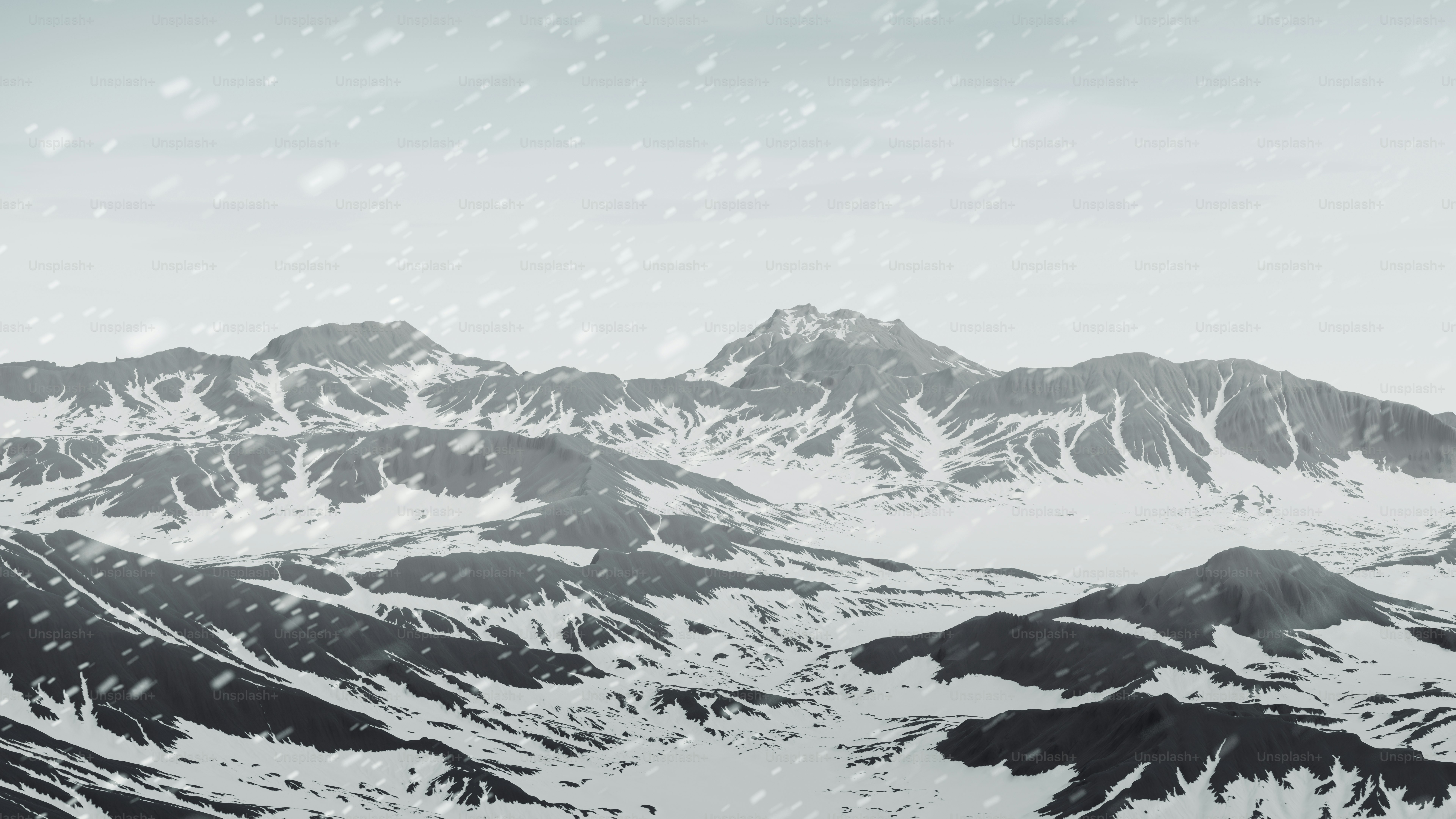 A snow covered mountain range under a cloudy sky photo – Winter Image ...