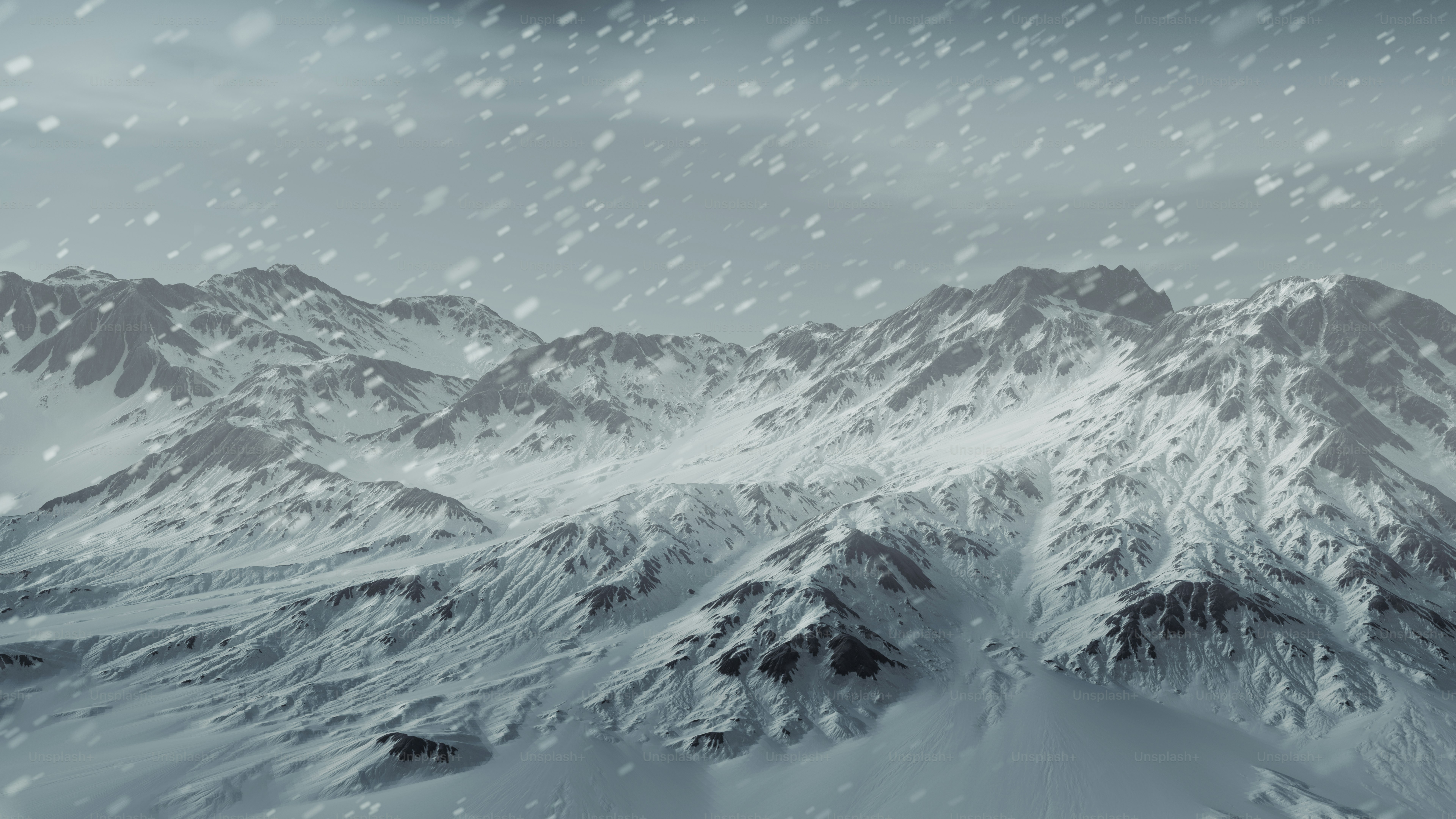 A snow covered mountain range under a cloudy sky photo – Winter Image ...