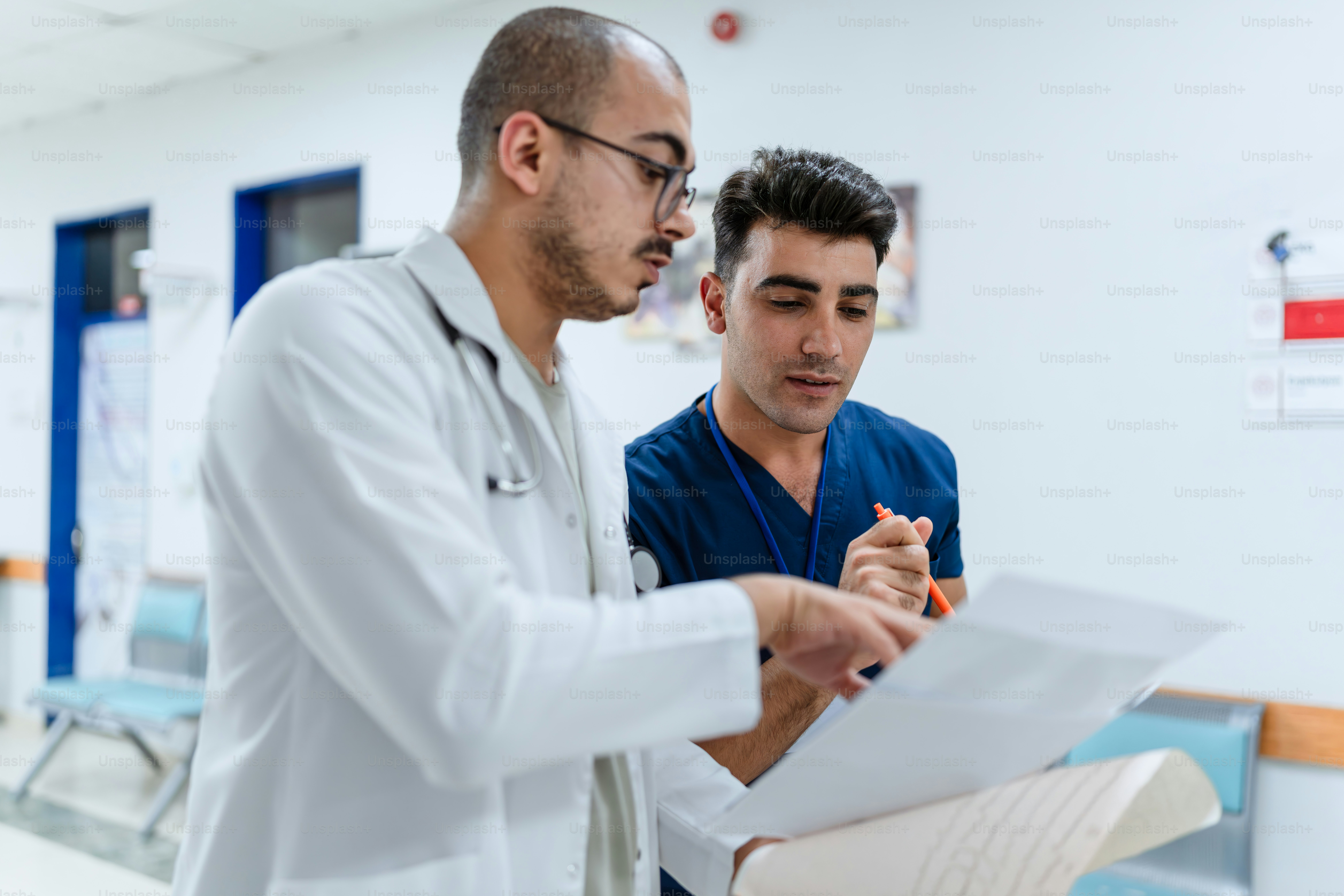 Two doctors looking at a clipboard in a hospital photo – Medical ...