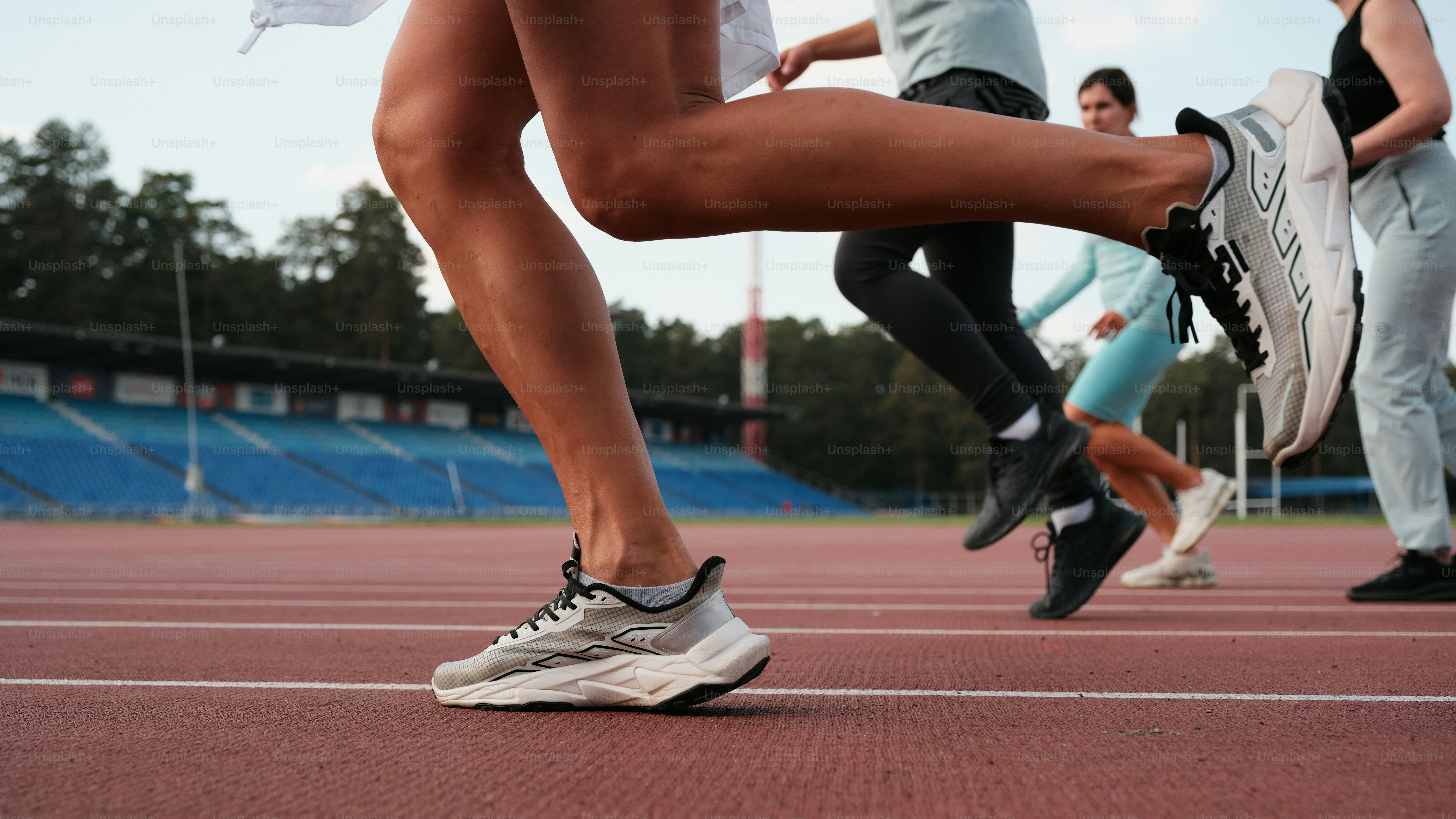 A group of women running across a track photo – Fitness Image on Unsplash