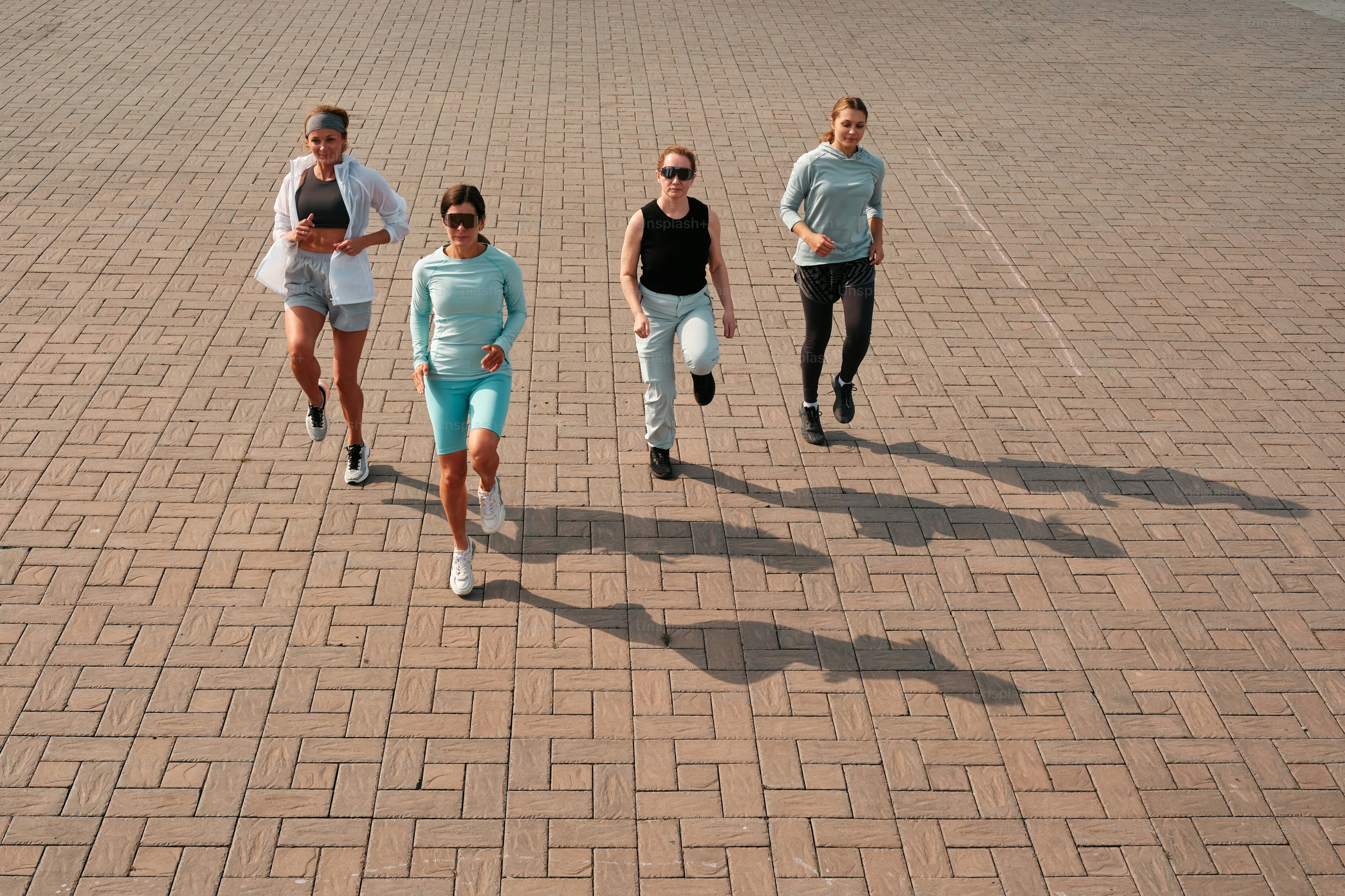 A group of women running across a track photo – Running Image on Unsplash