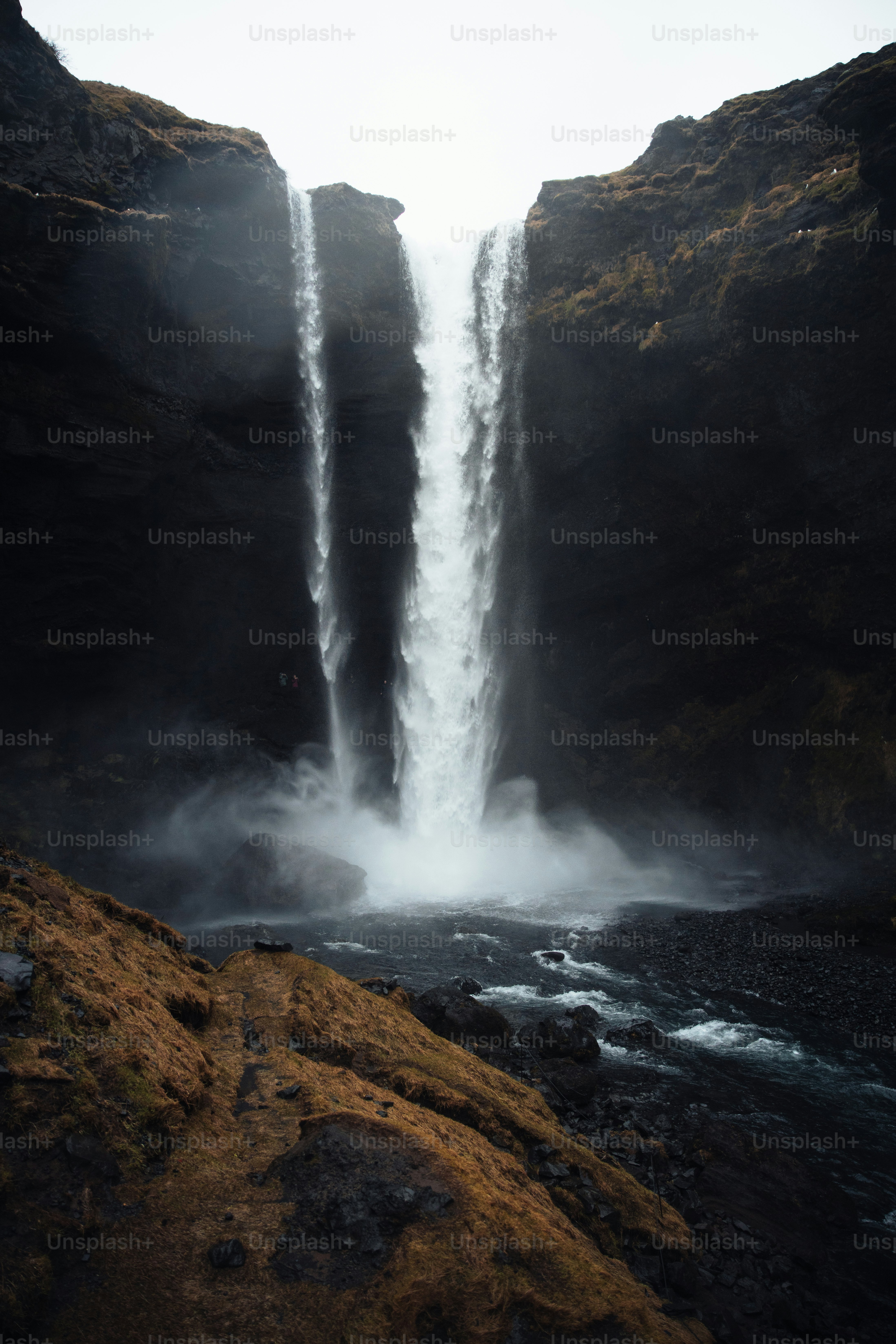 A very tall waterfall in the middle of a mountain photo – Nature Image ...