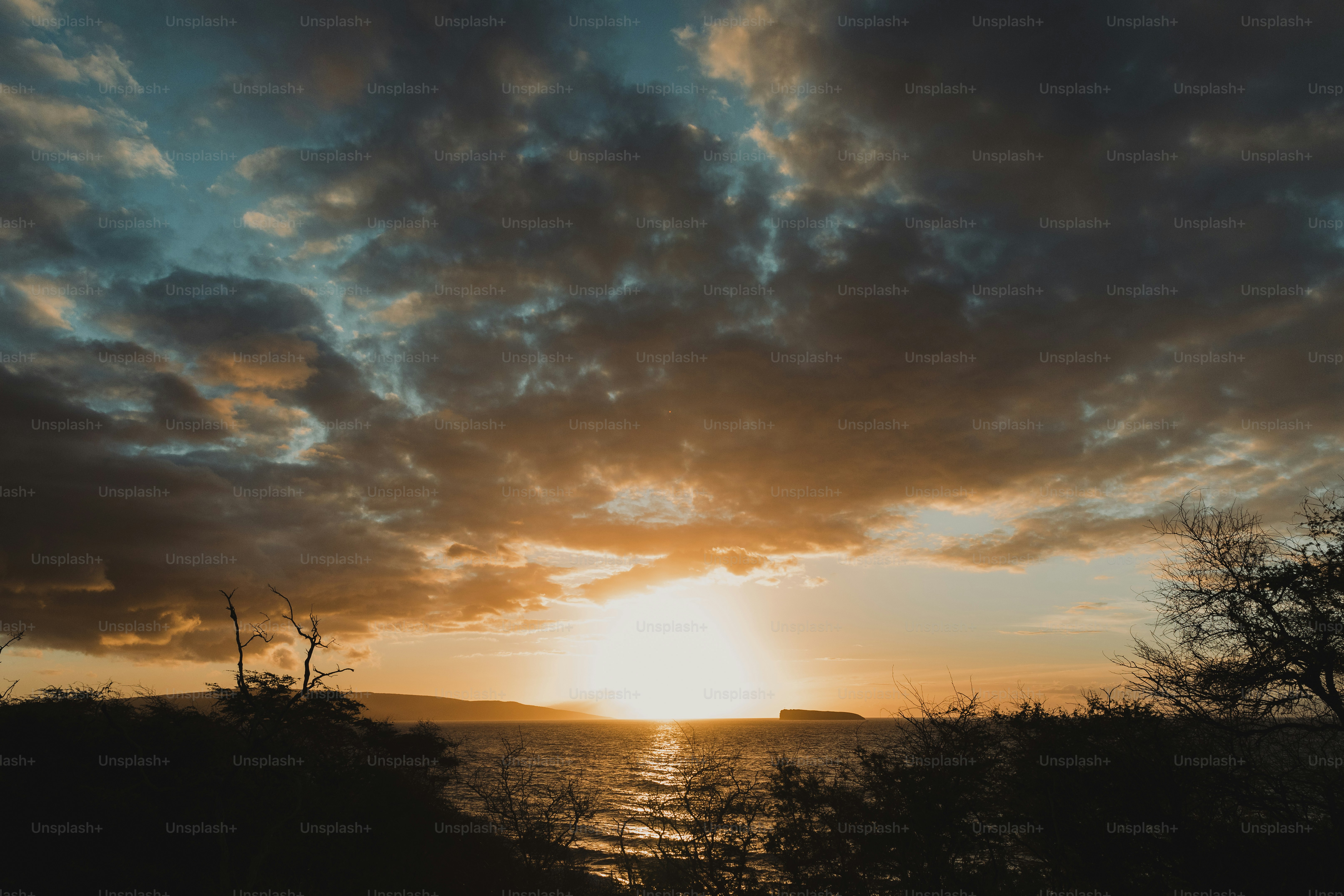 The sun is setting over a body of water photo – Amalfi coast Image on ...