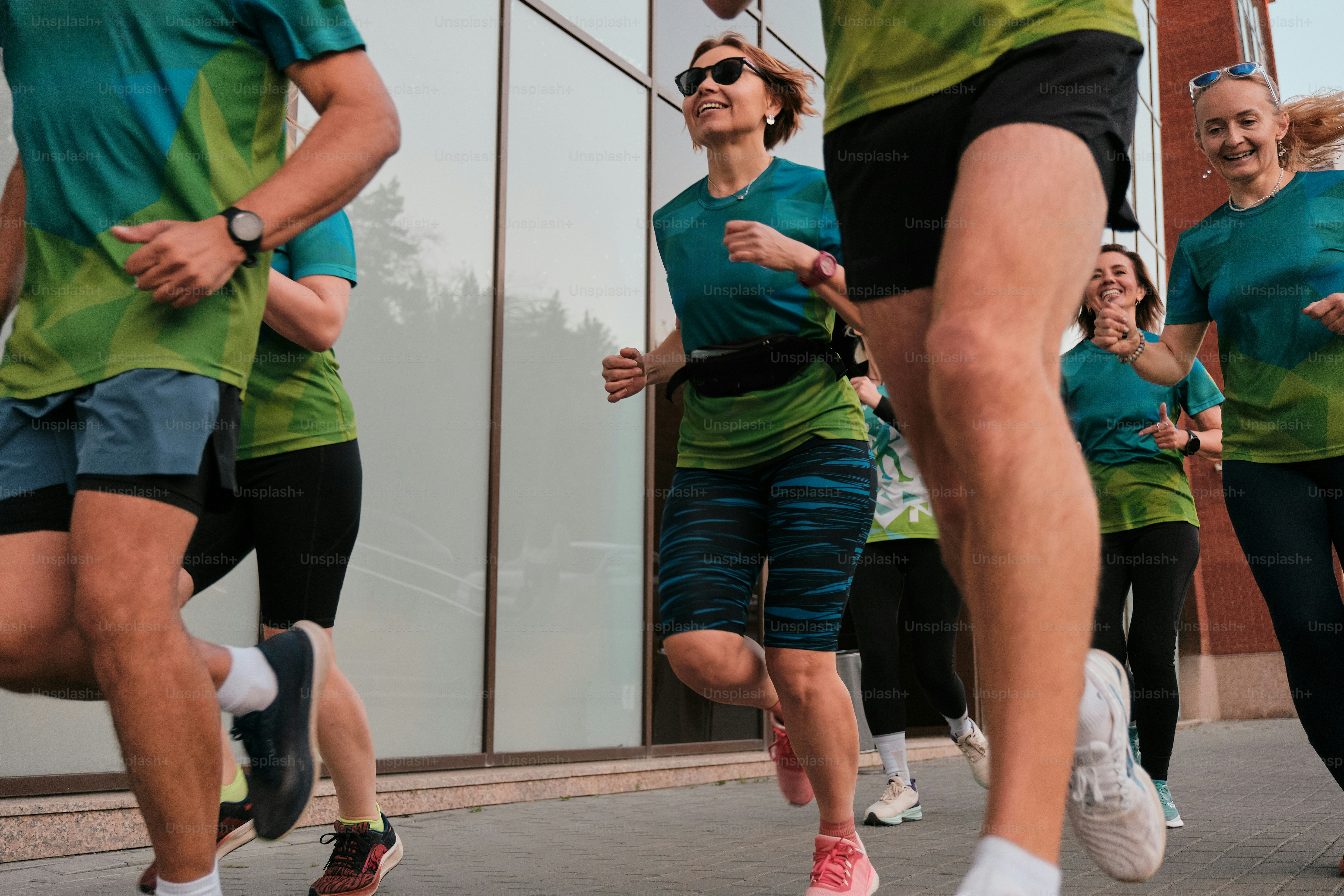 A group of people running down a street photo – Runners Image on Unsplash