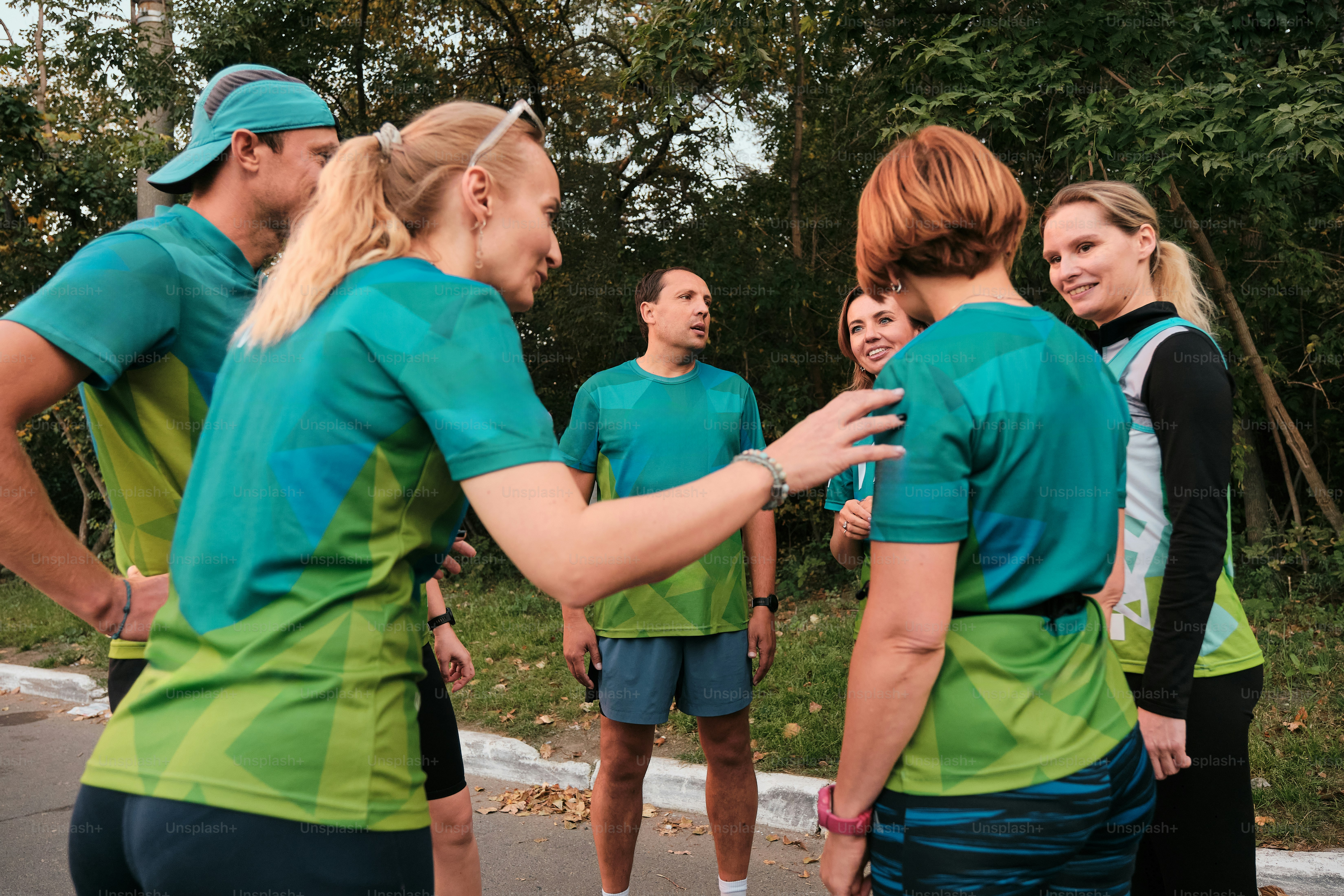 A group of people standing around each other photo – Fitness Image on ...