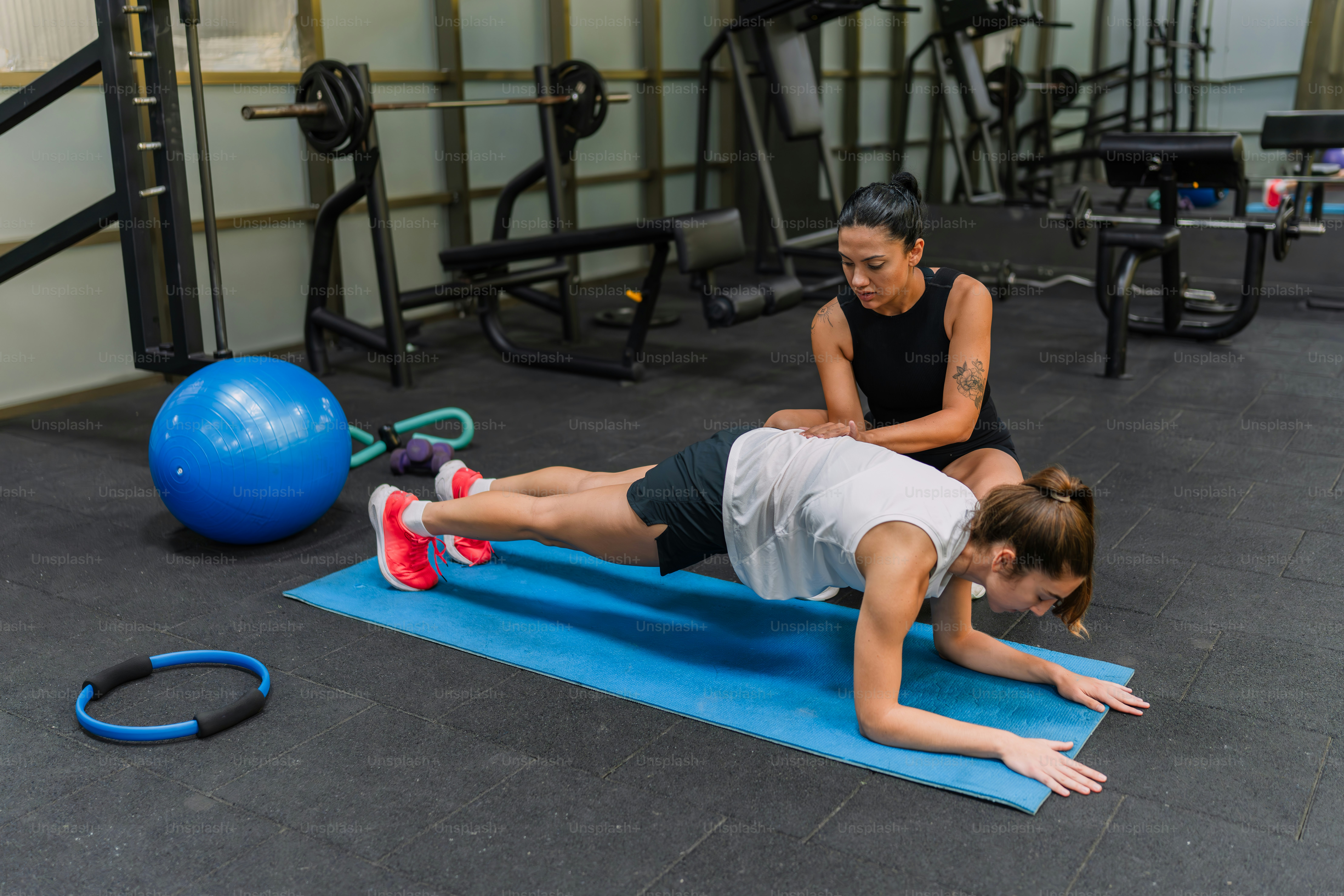 A man and a woman doing exercises on exercise mats photo – Personal ...