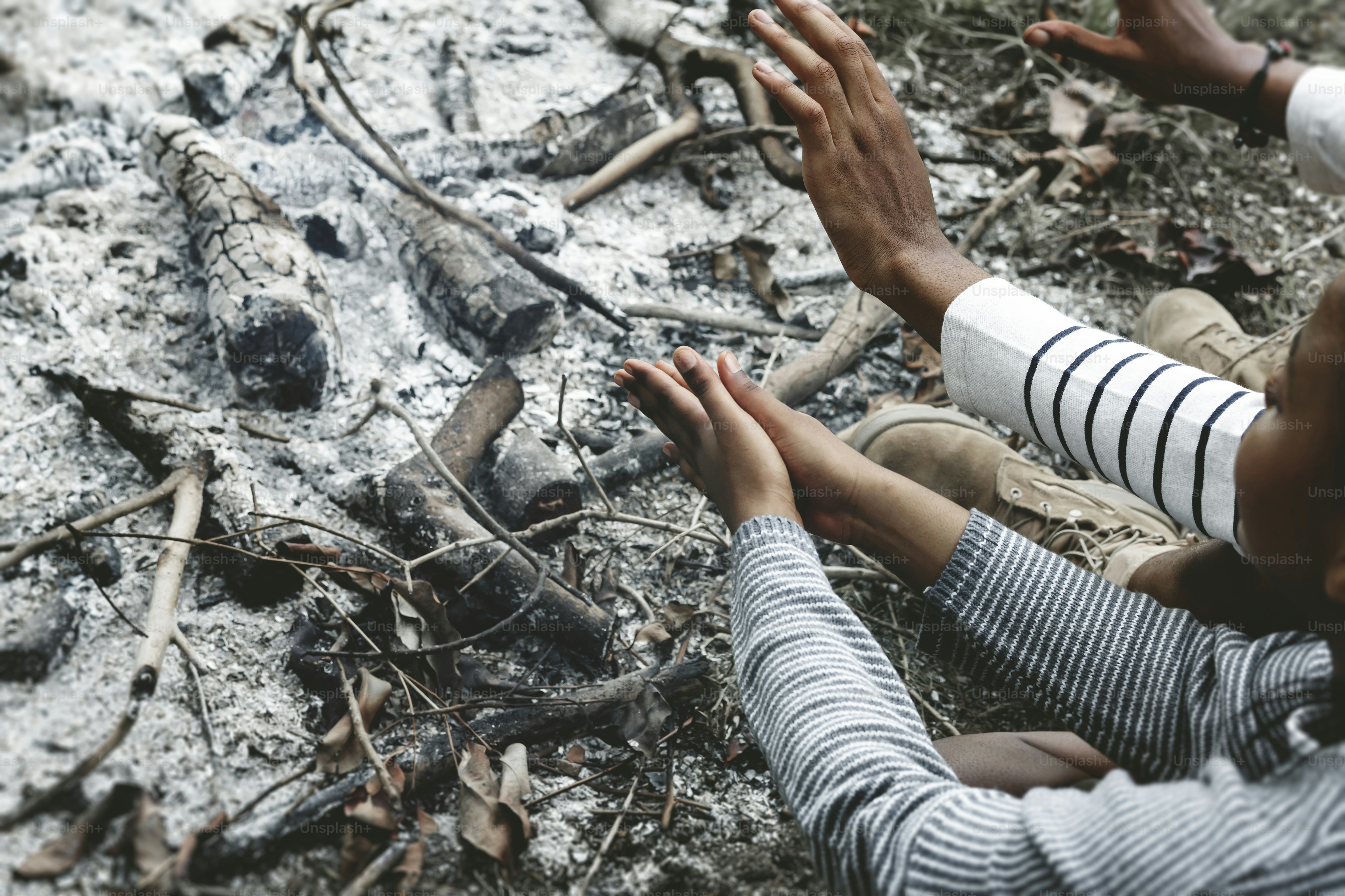 Warming hands by the campfire ashes photo – Camping Image on Unsplash