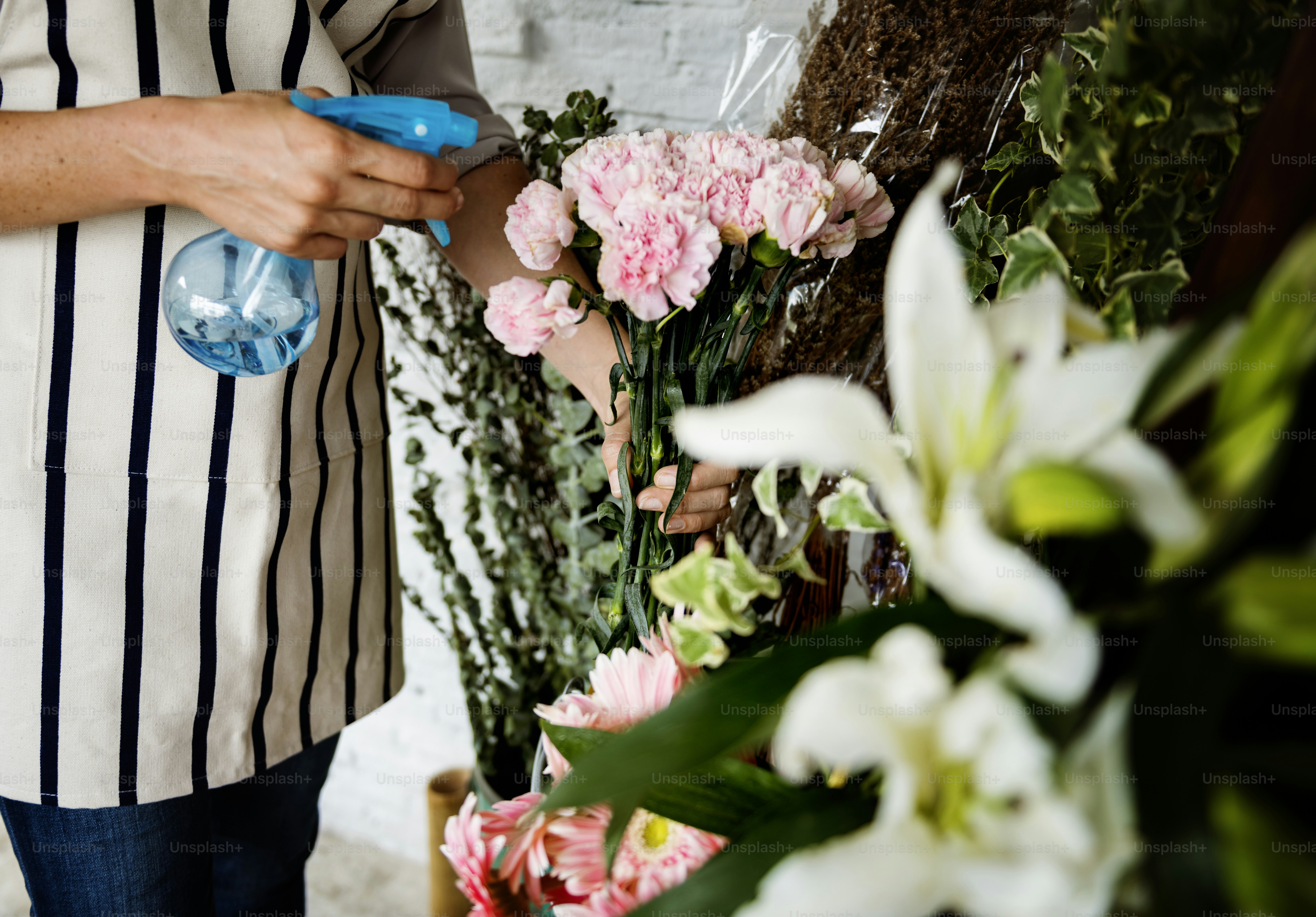 Woman Spraying Flowers to Refreshing in Flora Shop photo – Flower Image ...