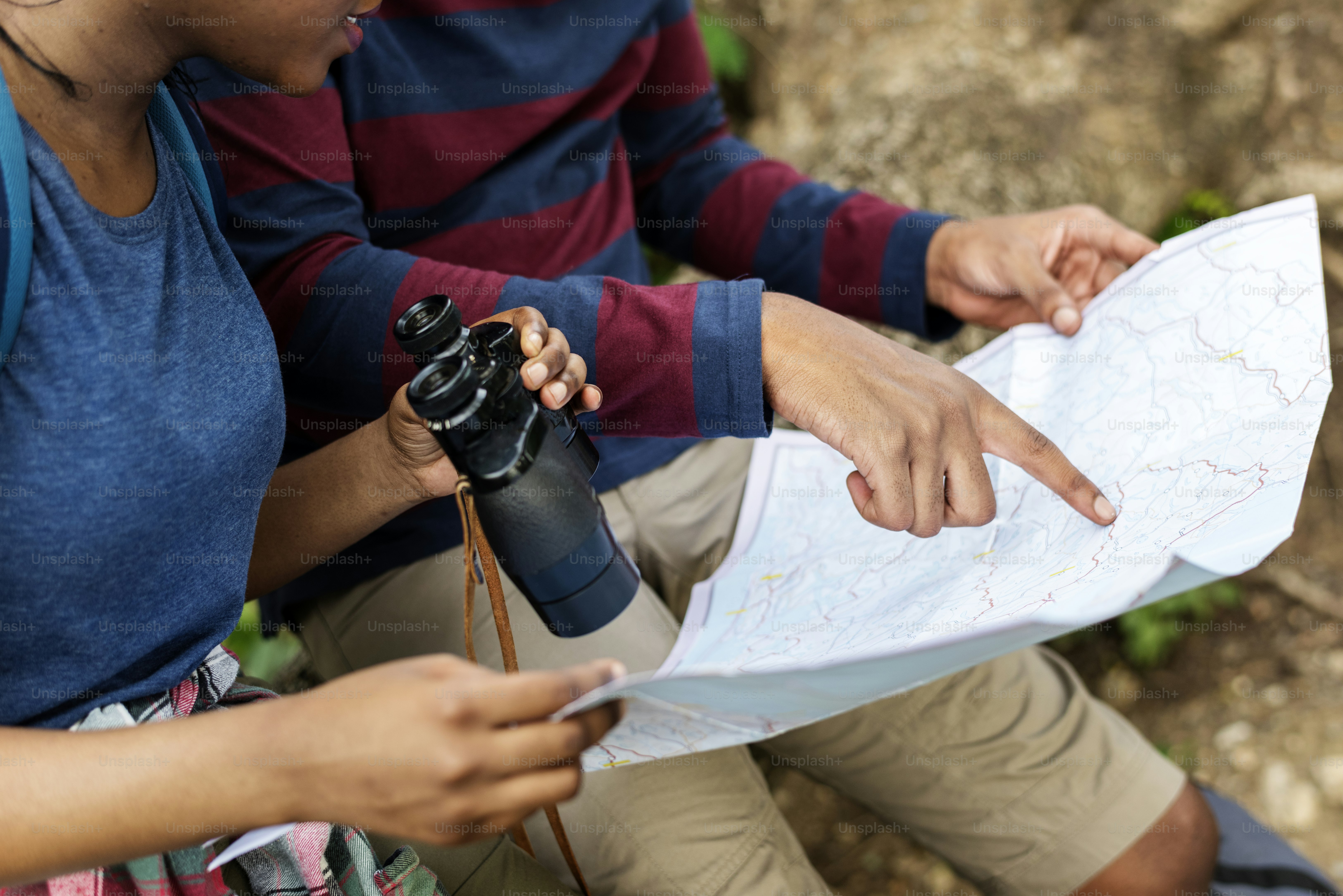 Trekking couple using a map in a forest ***These drawings are derived ...