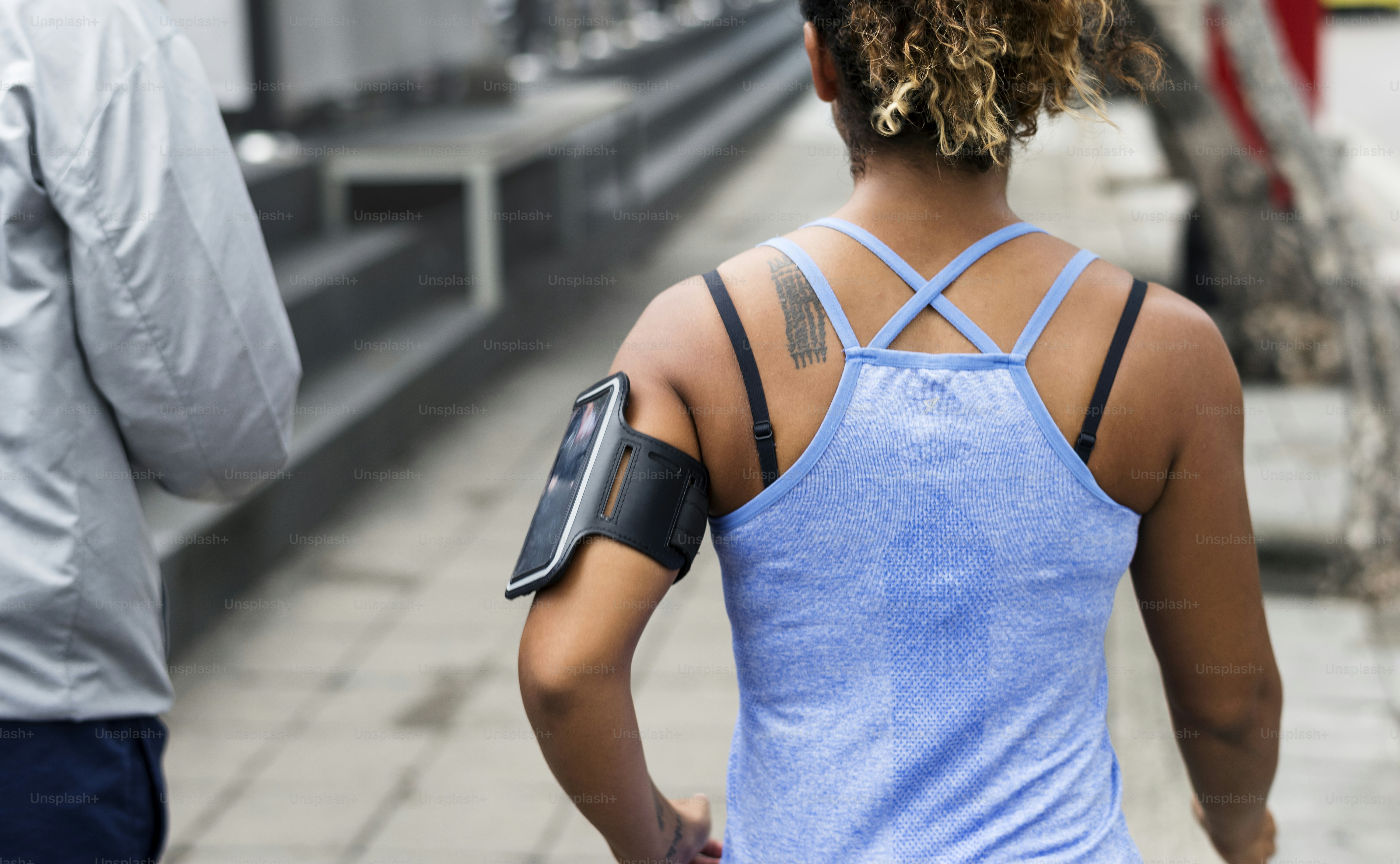Healthy woman exercising while using technology photo – Black people ...