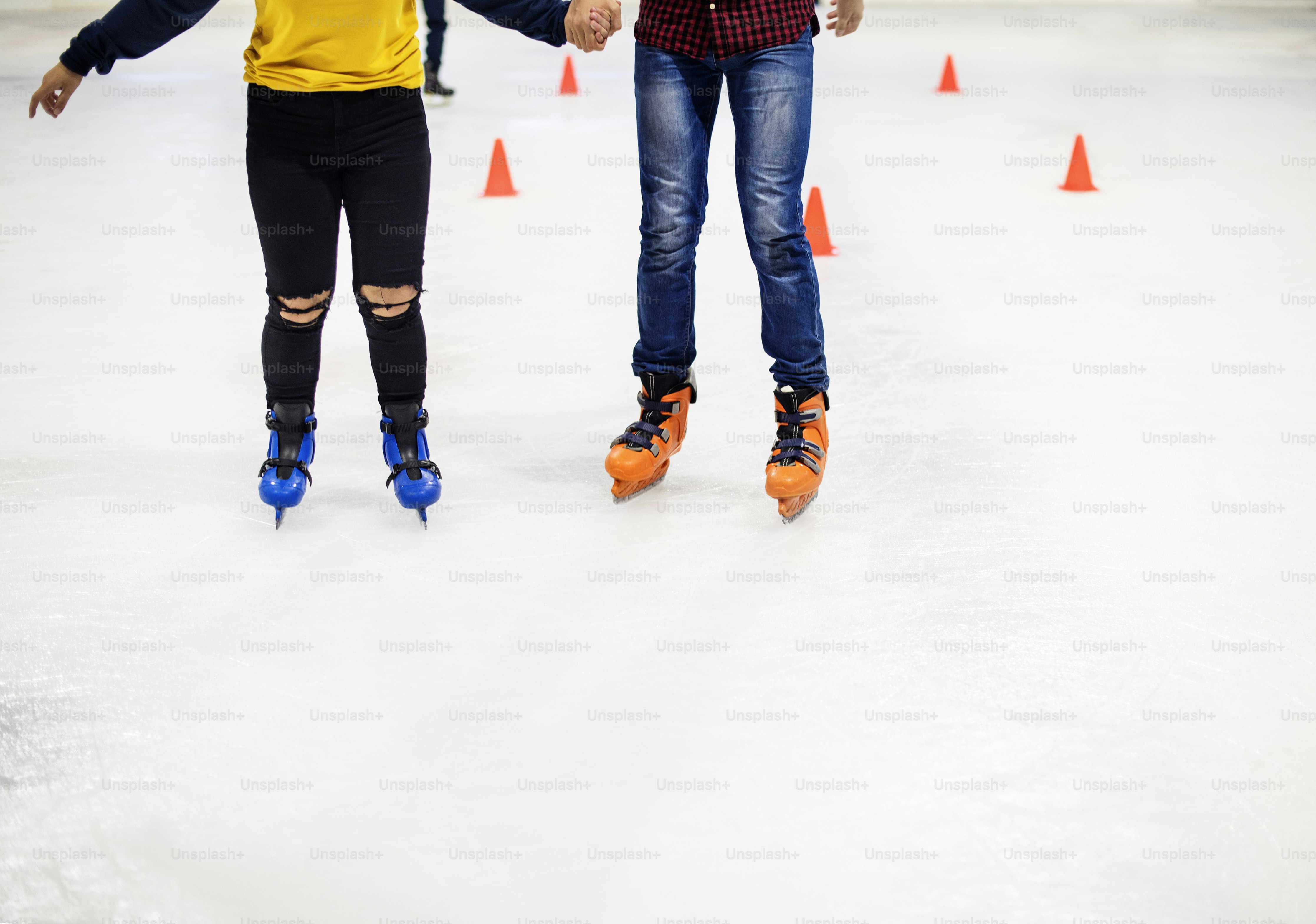 Group of teenage friends ice skating on an ice rink photo – White ...