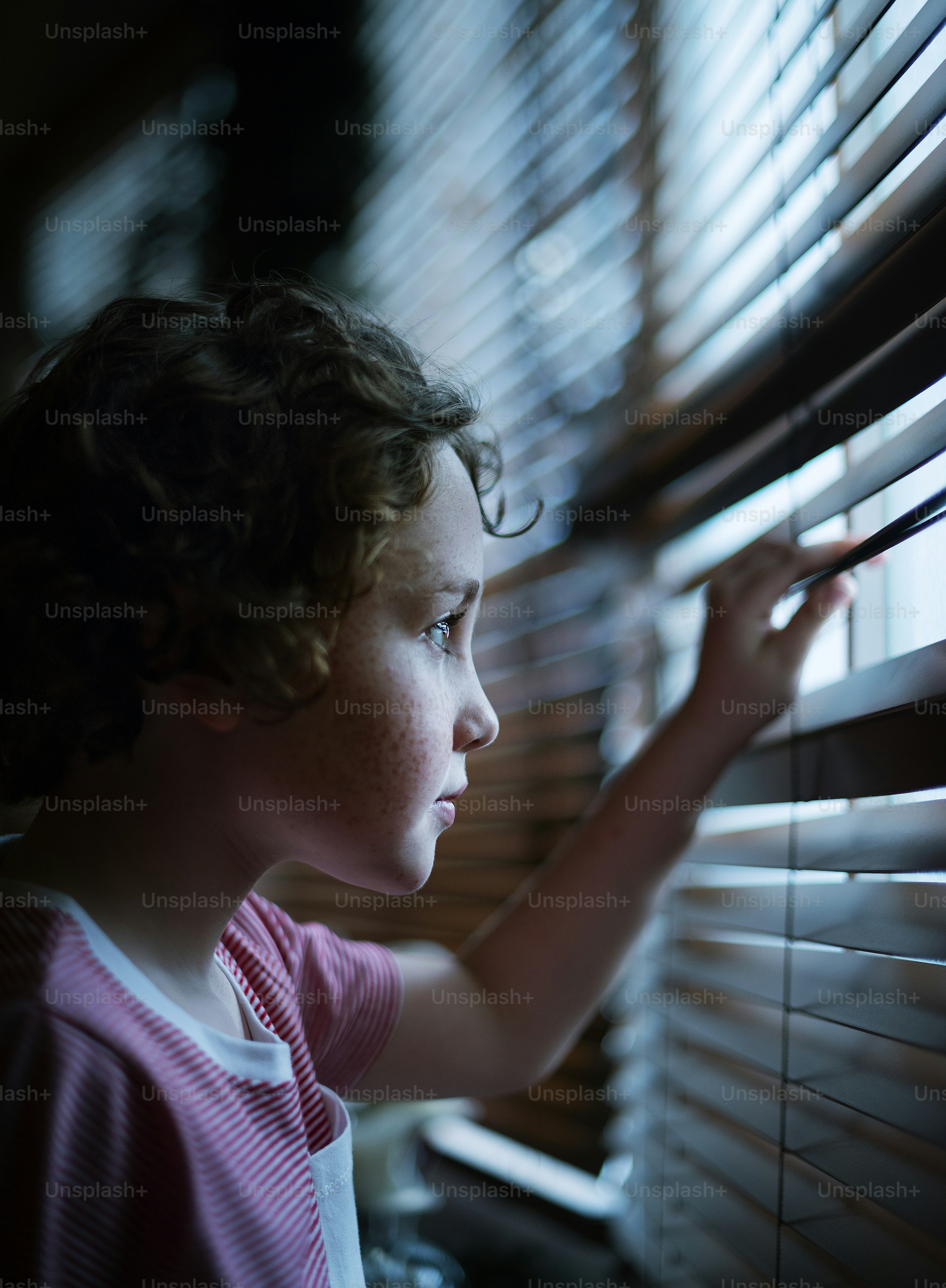 Young Caucasian boy waiting staring at a window photo – Children only ...