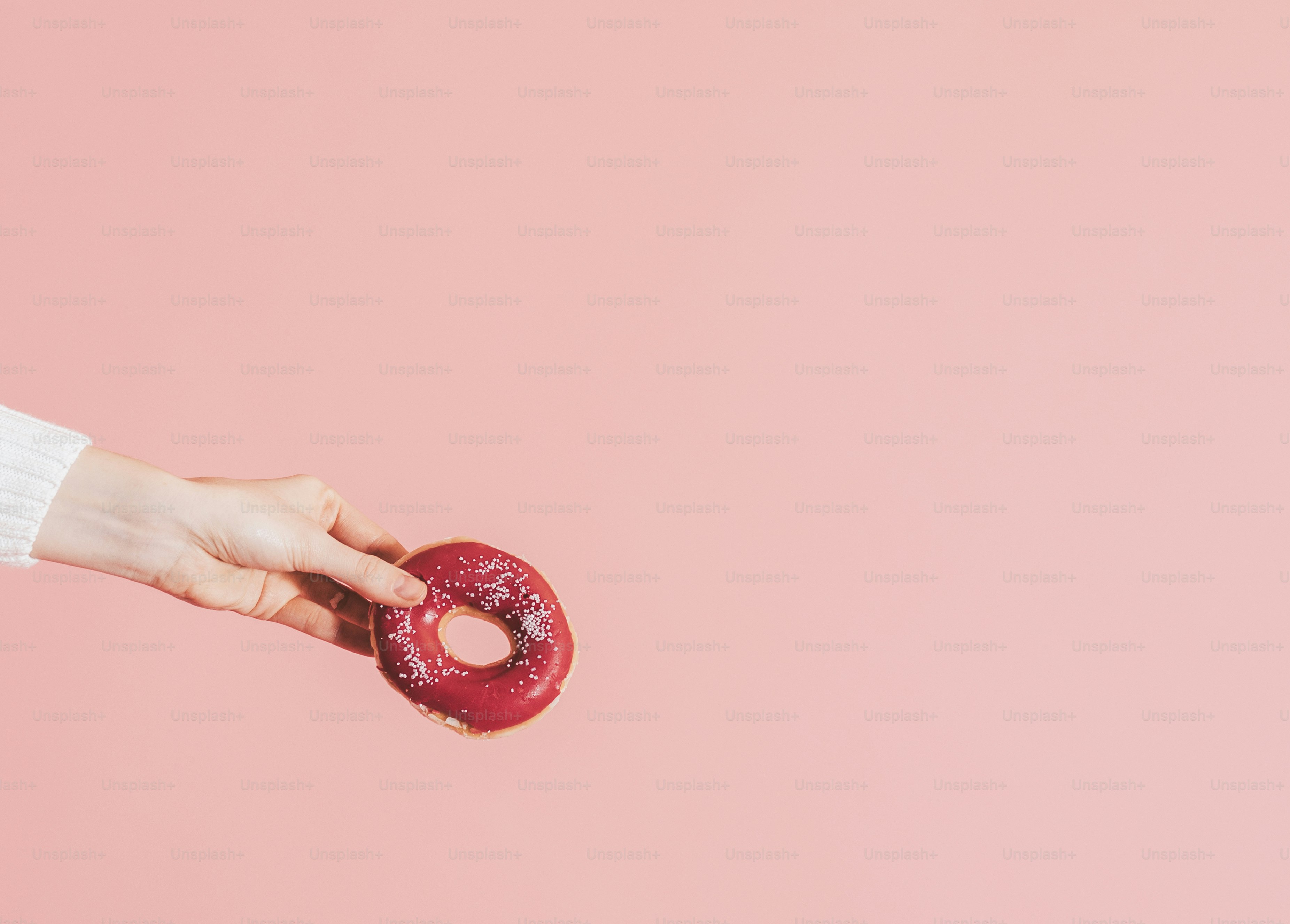 Woman holding a glazed donut photo – Human body part Image on Unsplash