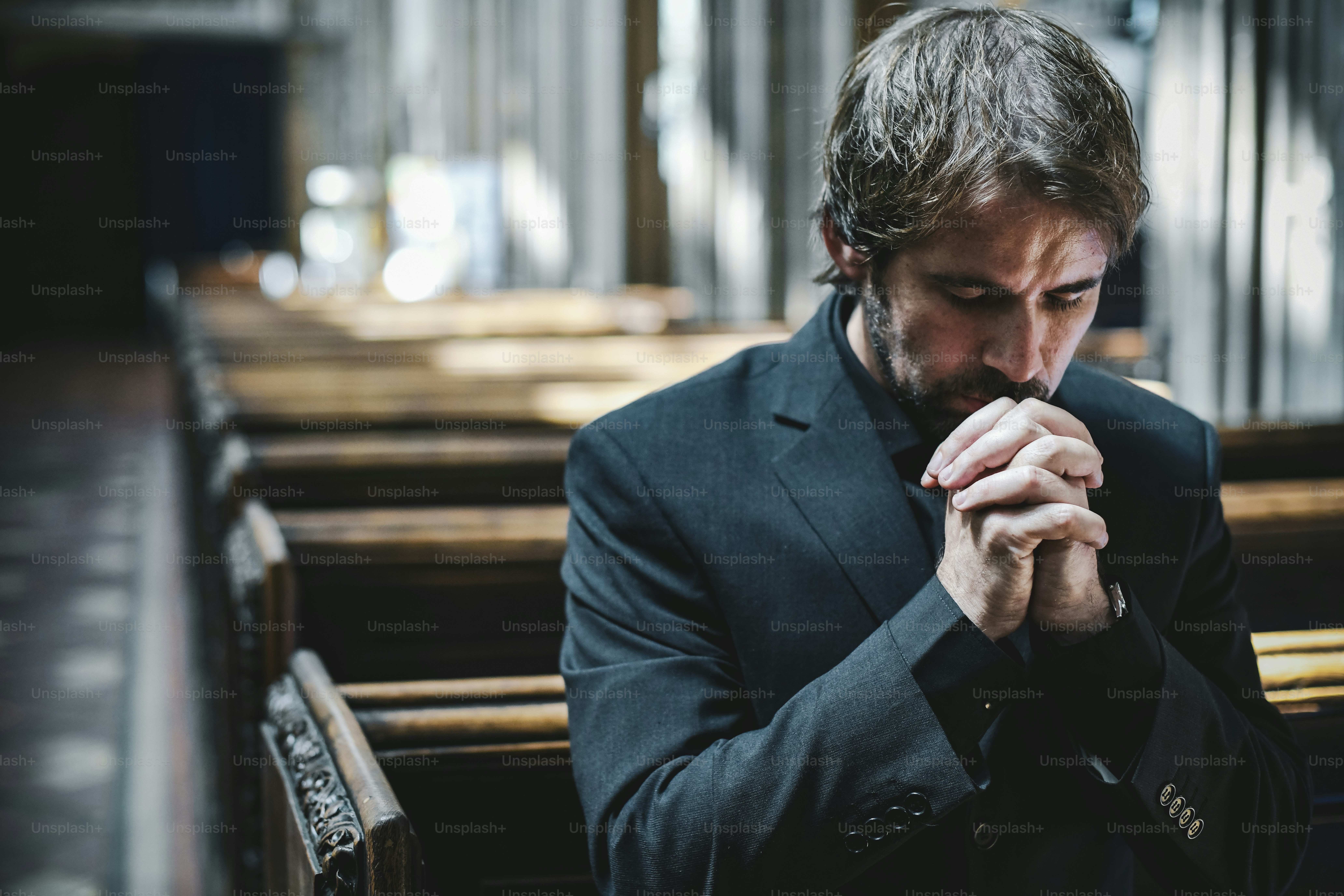 Lonely Christian man praying in the church photo – Widower Image on ...