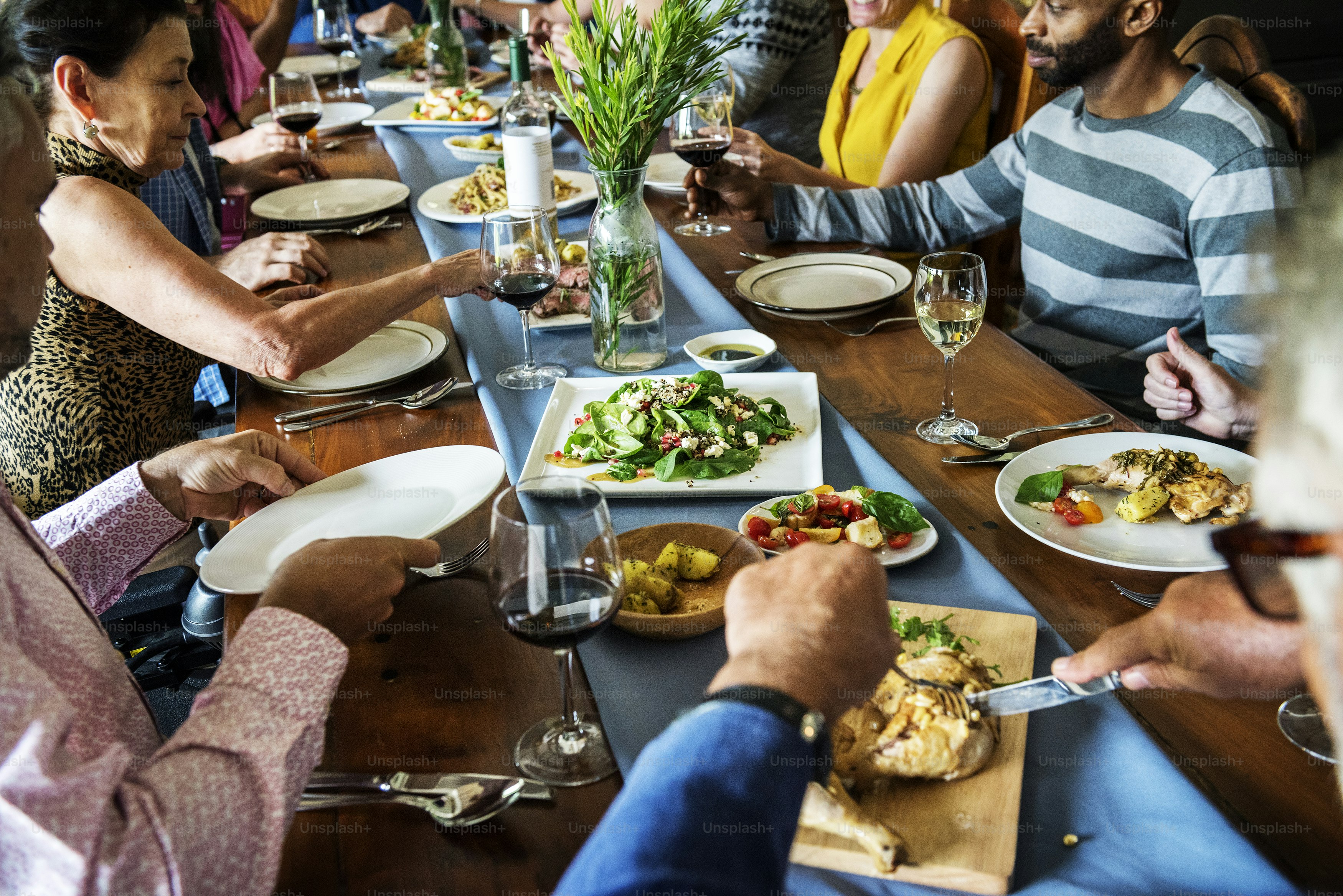 Group of diverse friends are having a dinner together photo – Food ...