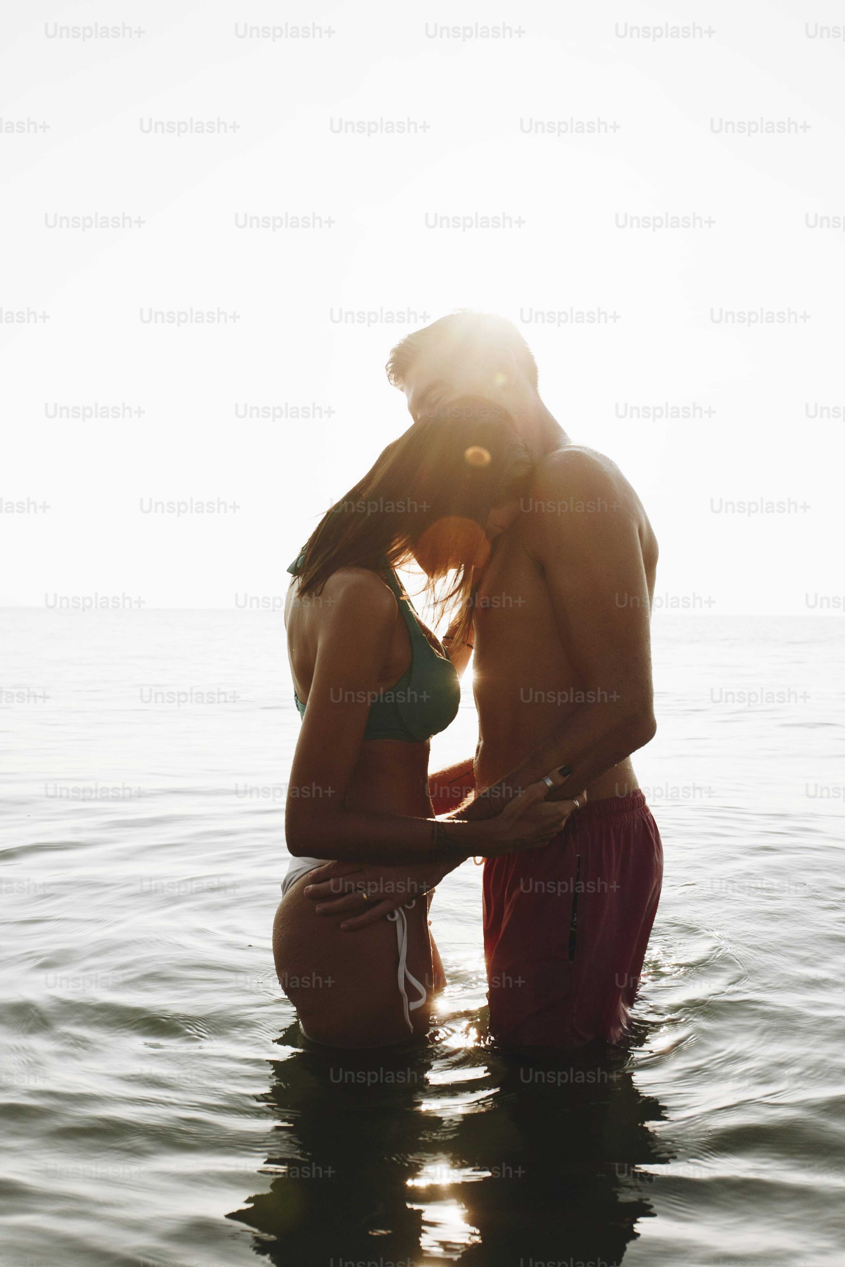 Romantic couple in the sea at sunset photo – Travel Image on Unsplash