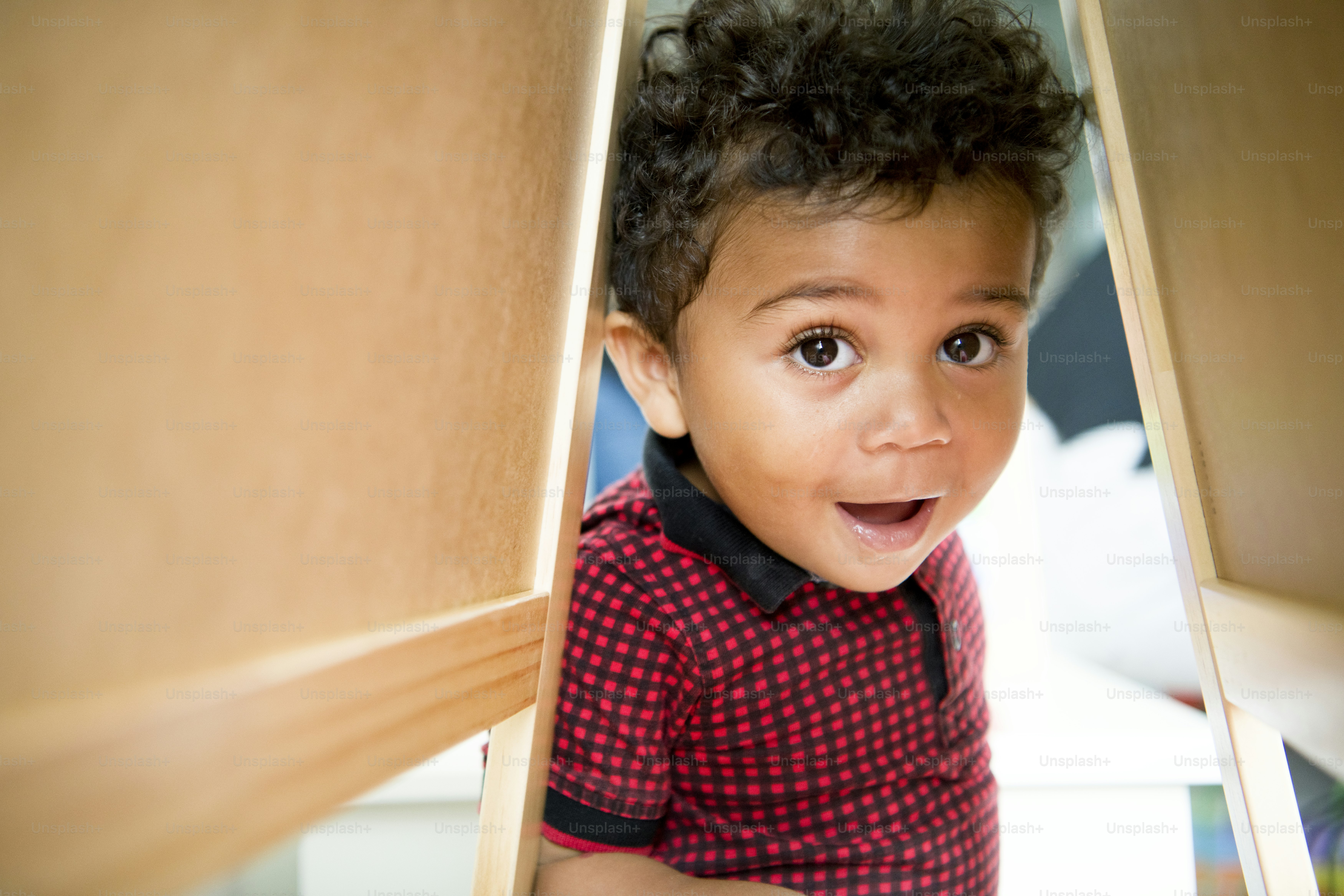 Cute kid hiding between a wooden board photo – Photography Image on ...