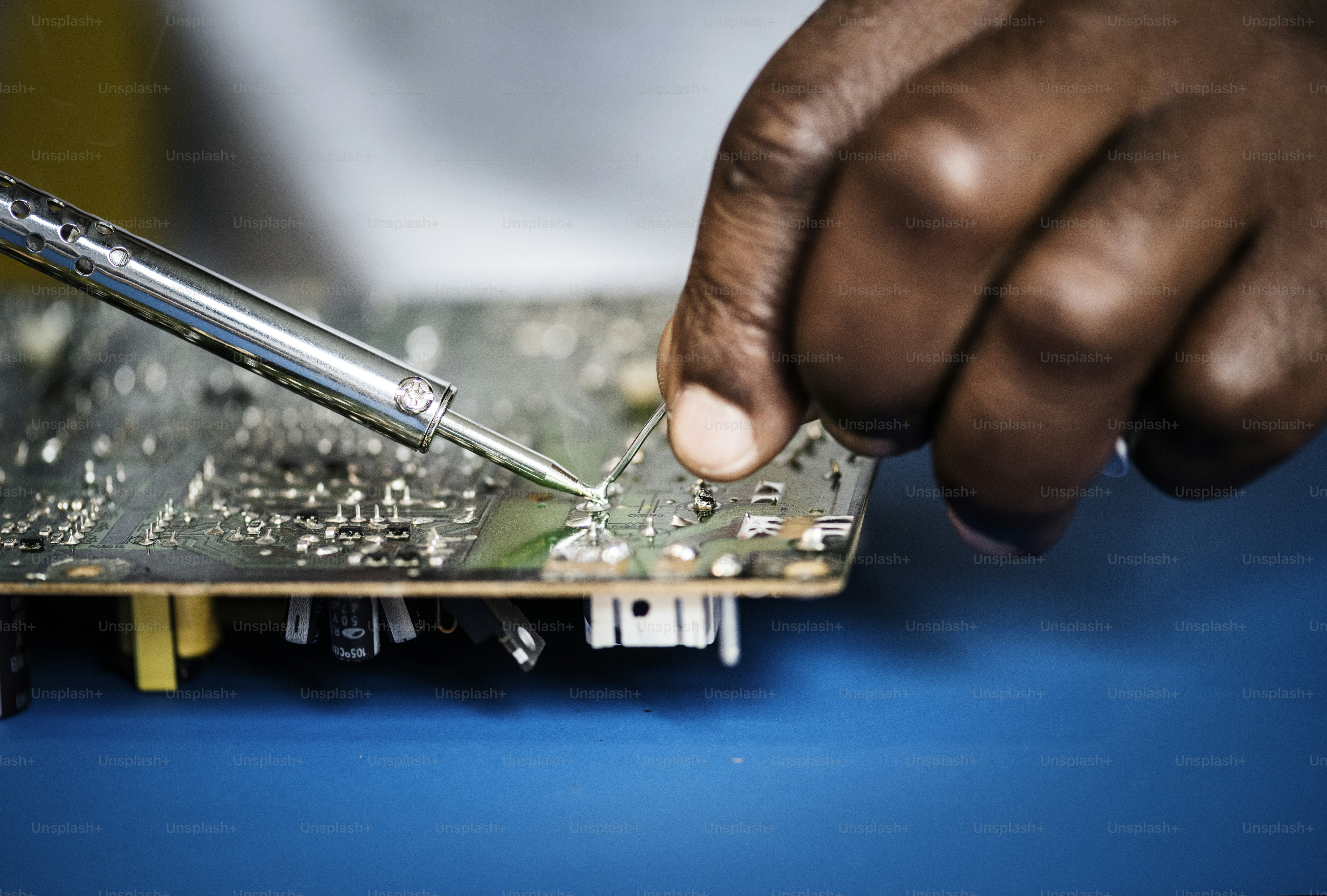 Closeup of tin soldering with electronics circuit board photo ...