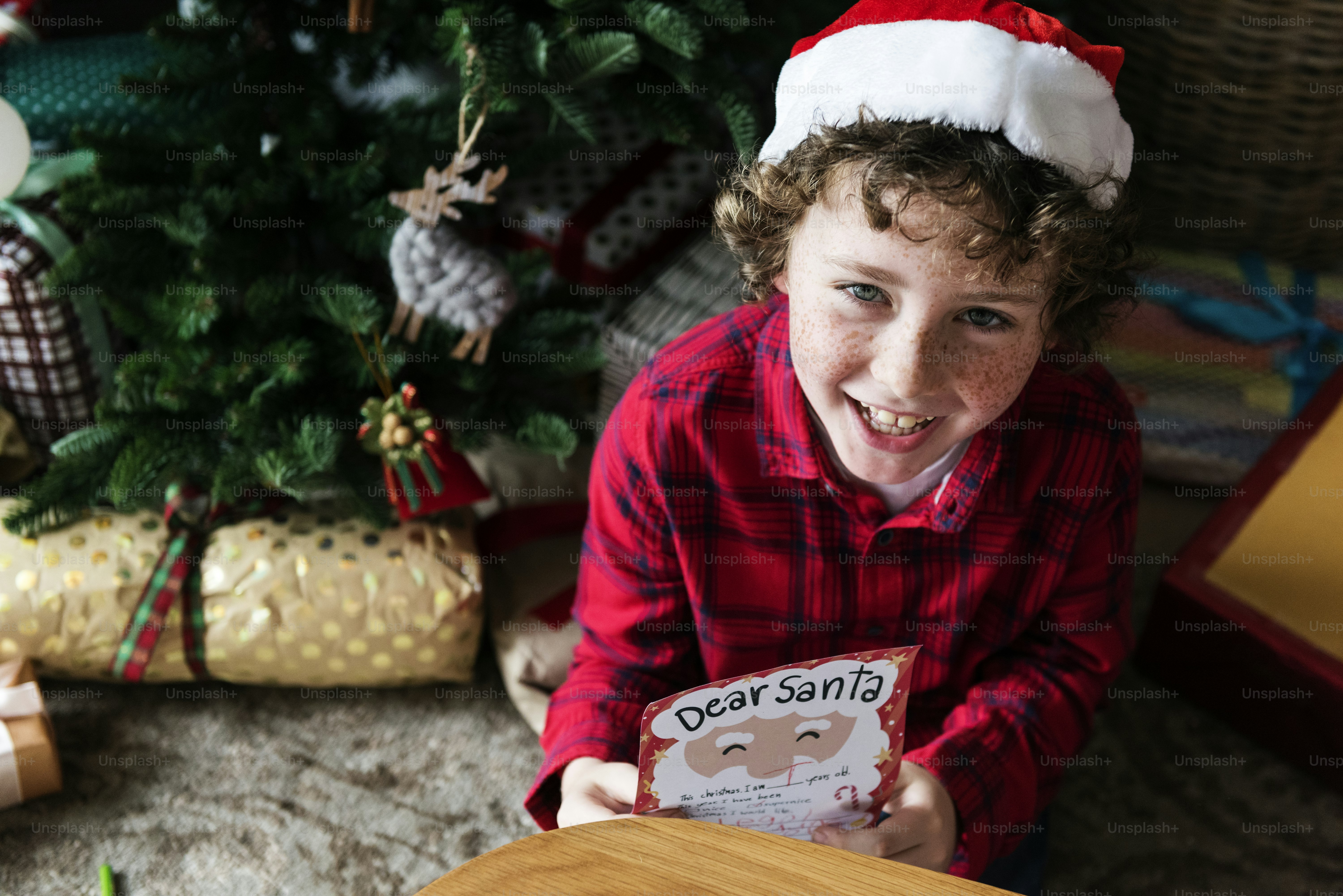 Kid with Christmas wish list photo – Decorating the christmas tree ...