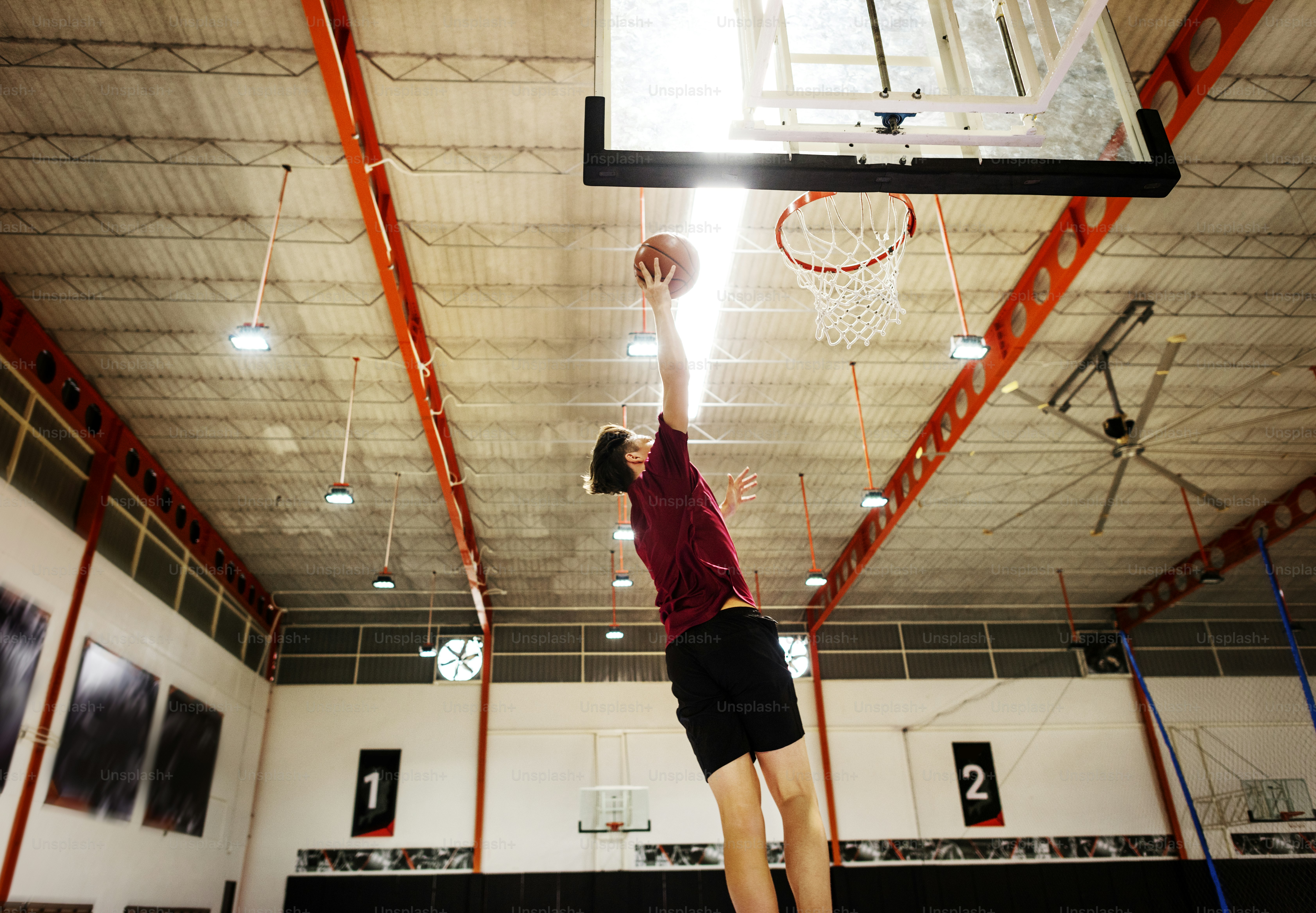 Caucasian teenage boy playing basketball alone on the court photo ...