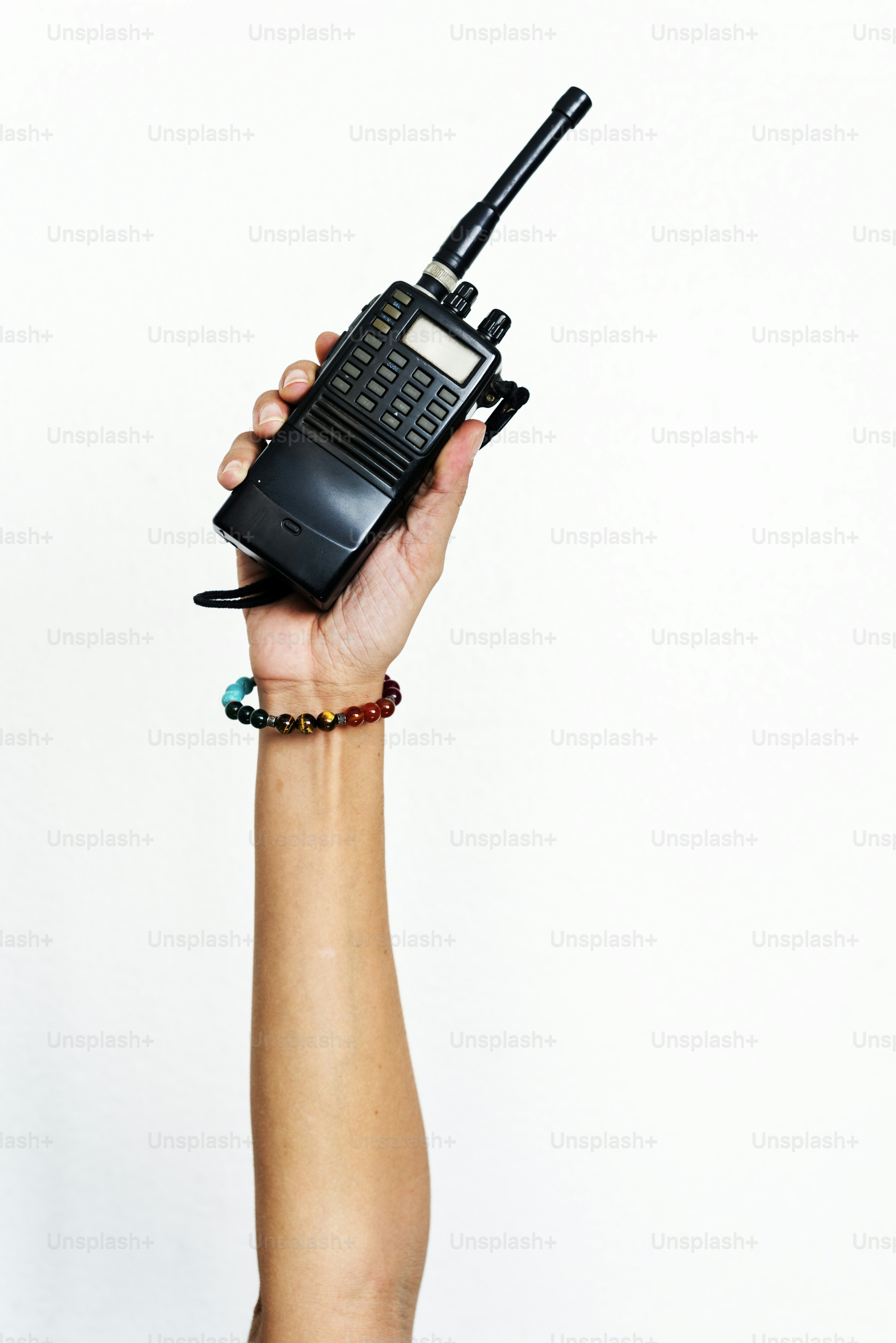 Hand holding portable two way radio isolated on white photo ...