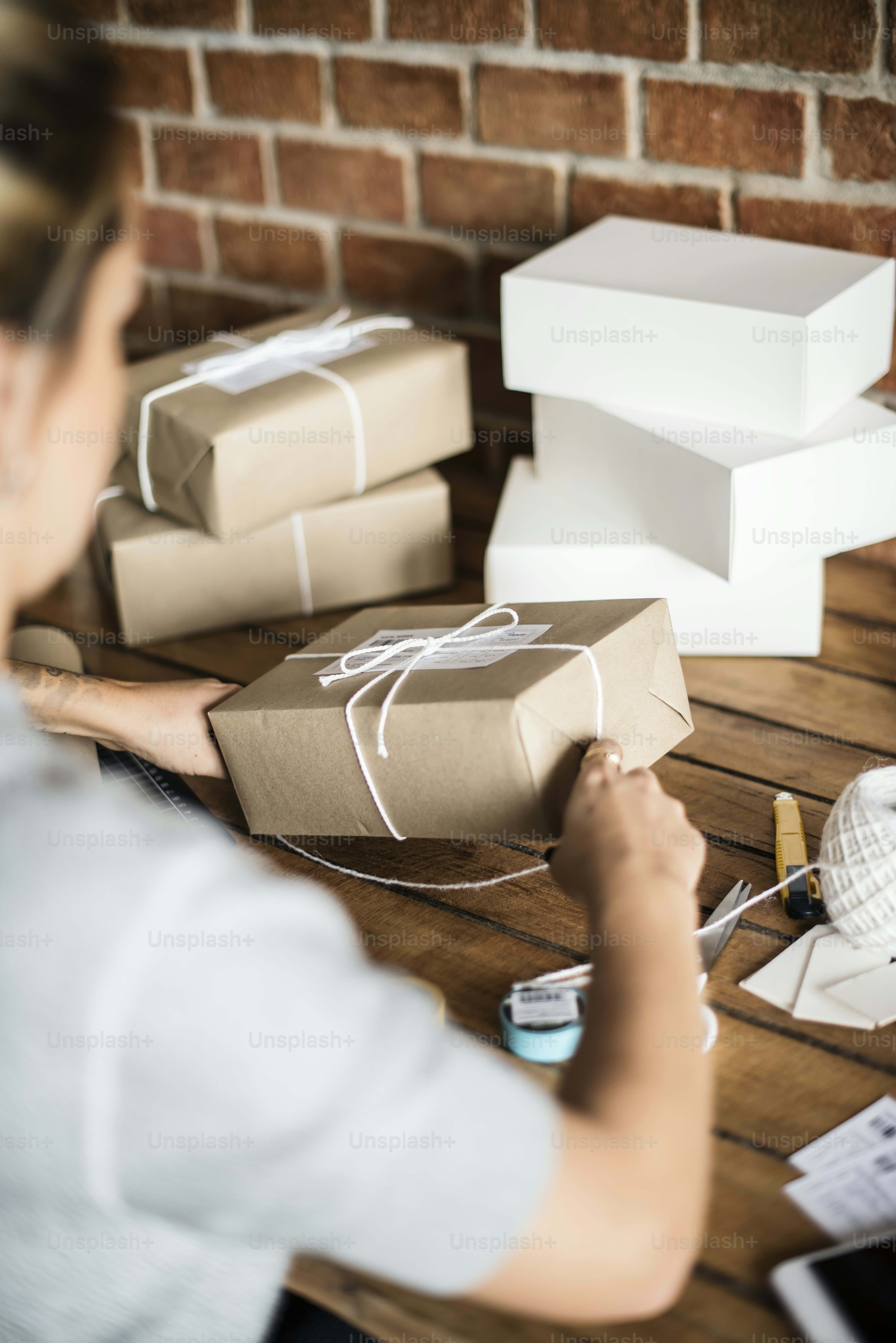 Woman packing parcels photo – One woman only Image on Unsplash