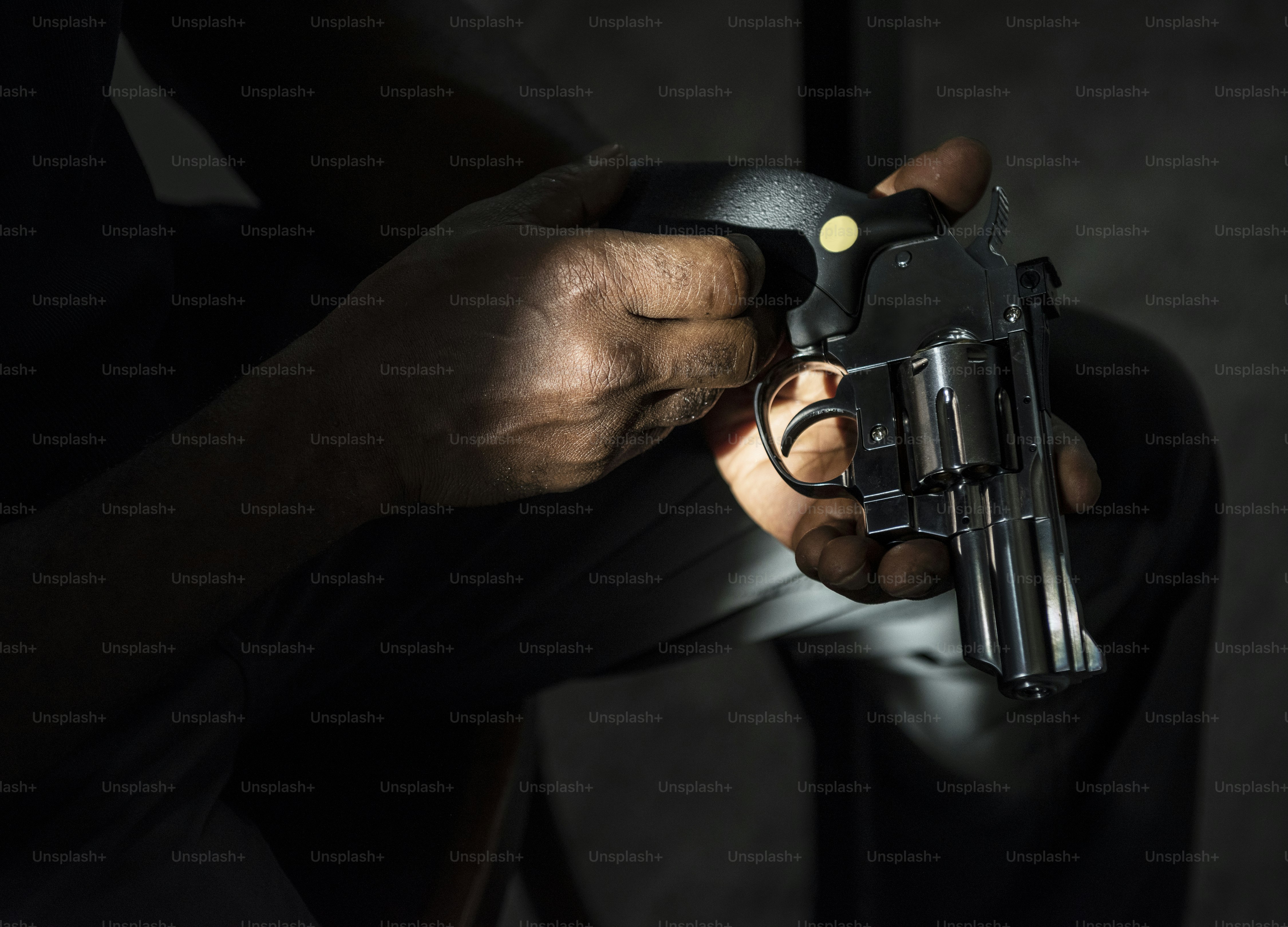 Hands holding the gun photo – Gunman Image on Unsplash