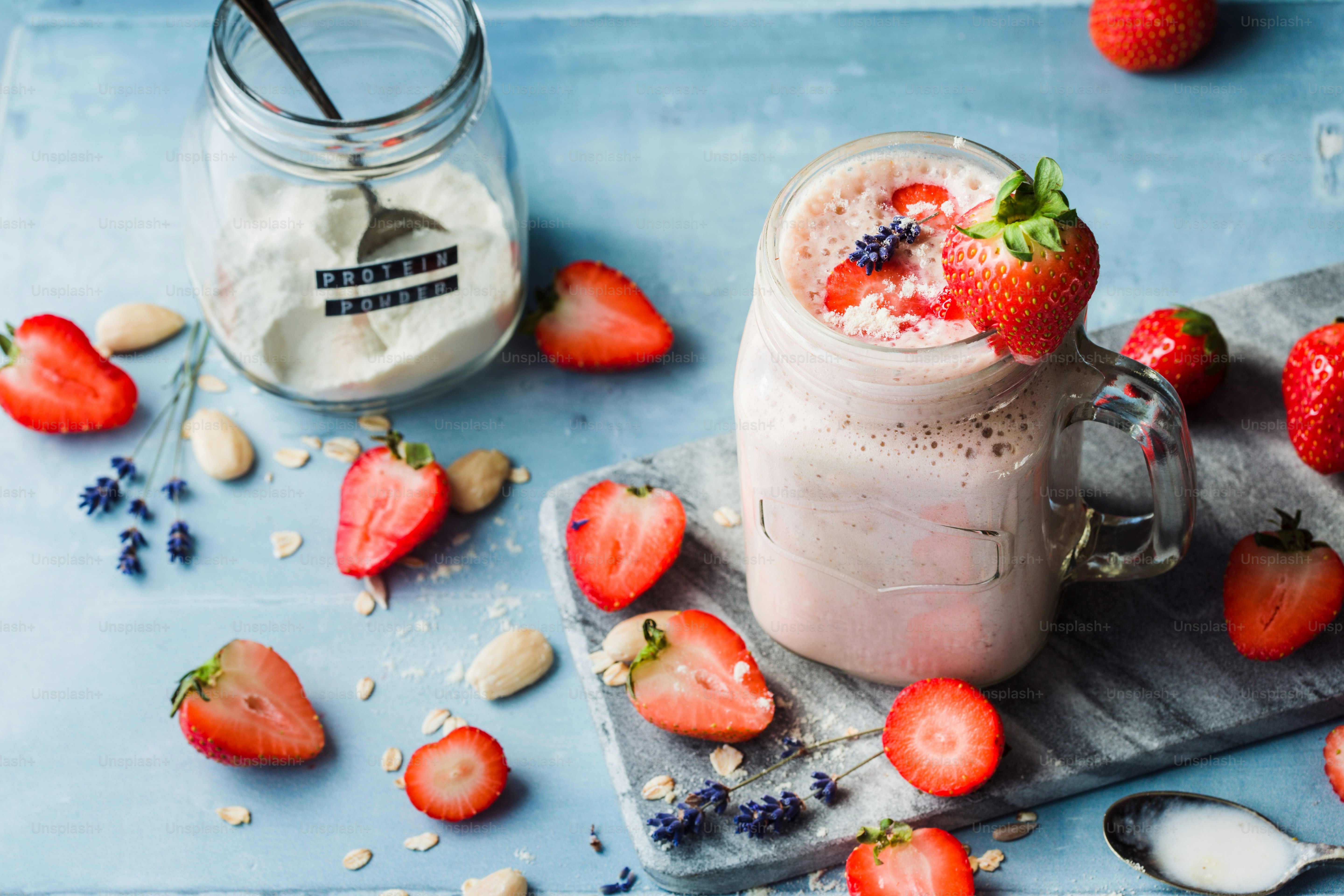 A glass of milkshake with strawberries on a tray photo – Workout foods ...