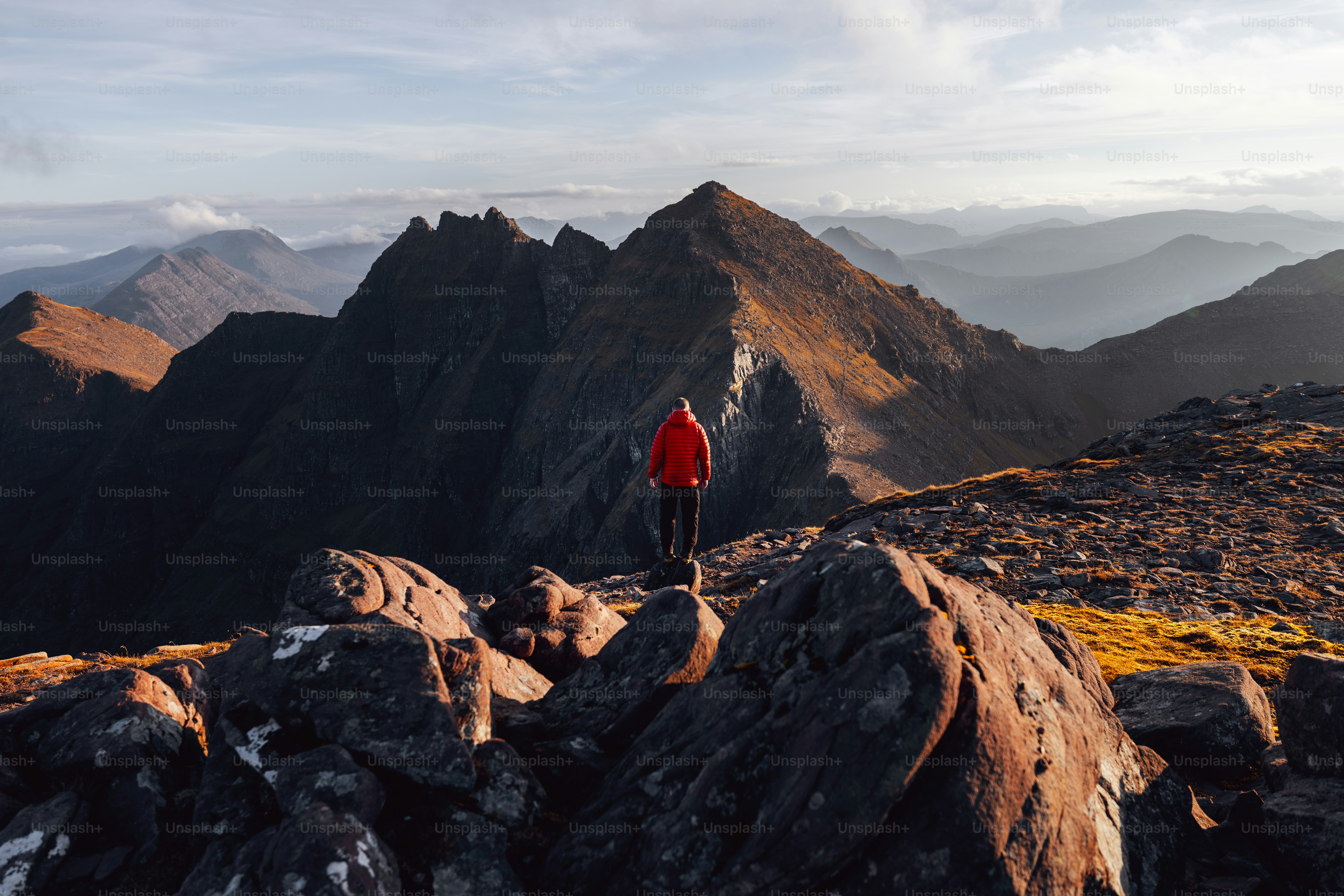 Un homme debout au sommet d’une montagne au coucher du soleil photo ...