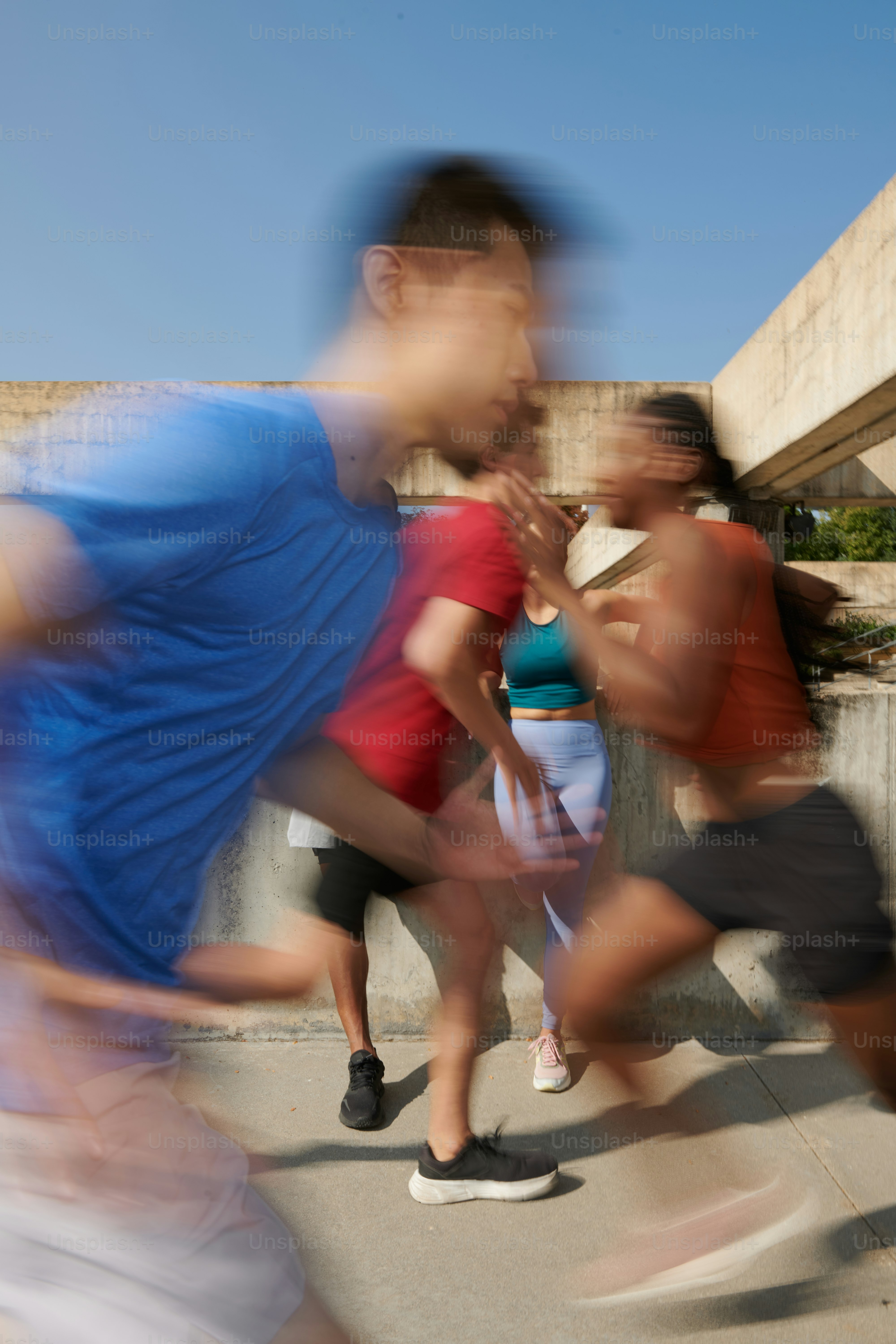 A blurry photo of a group of people running photo – Running Image on ...