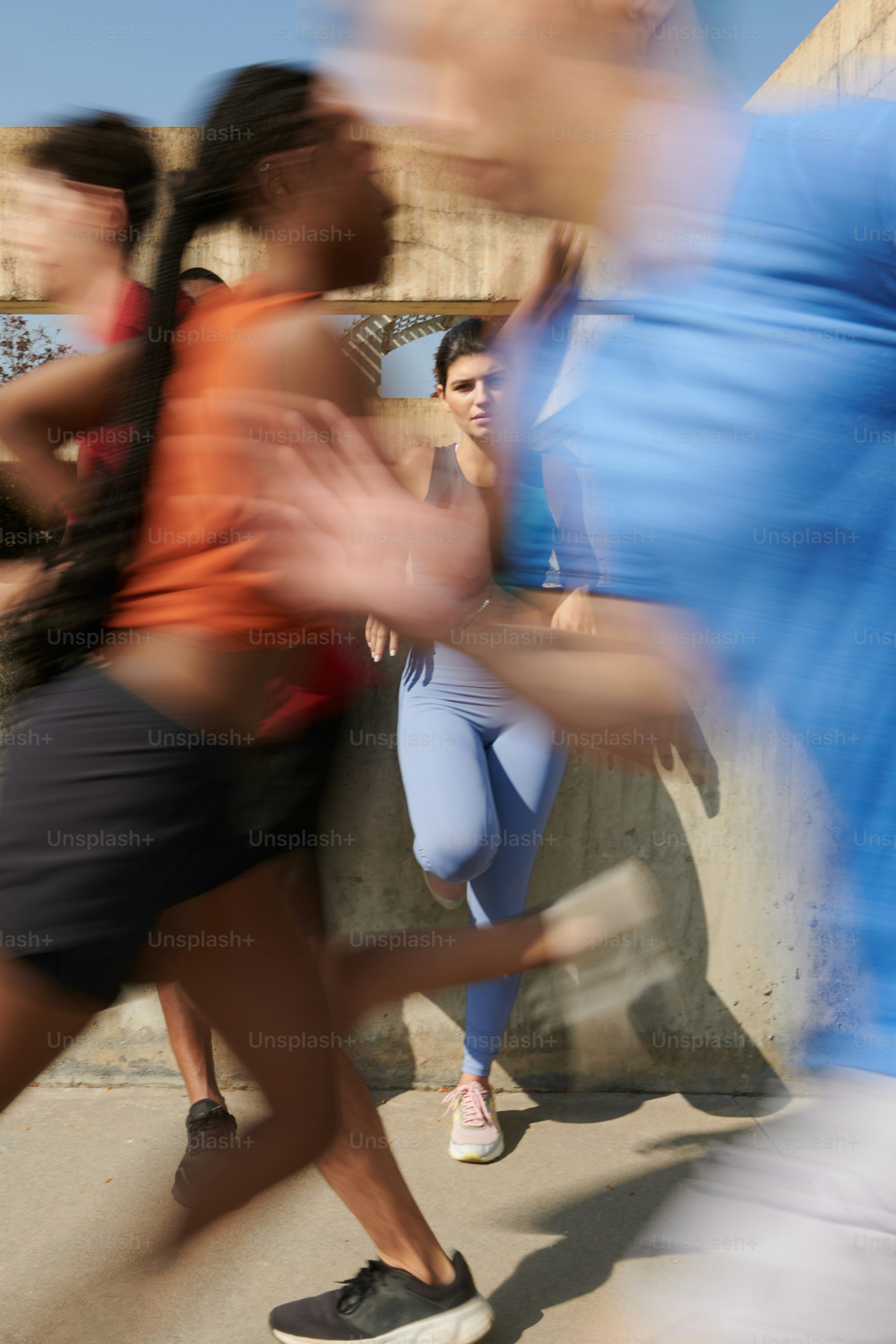 A blurry photo of a group of people running photo – Fitness Image on ...