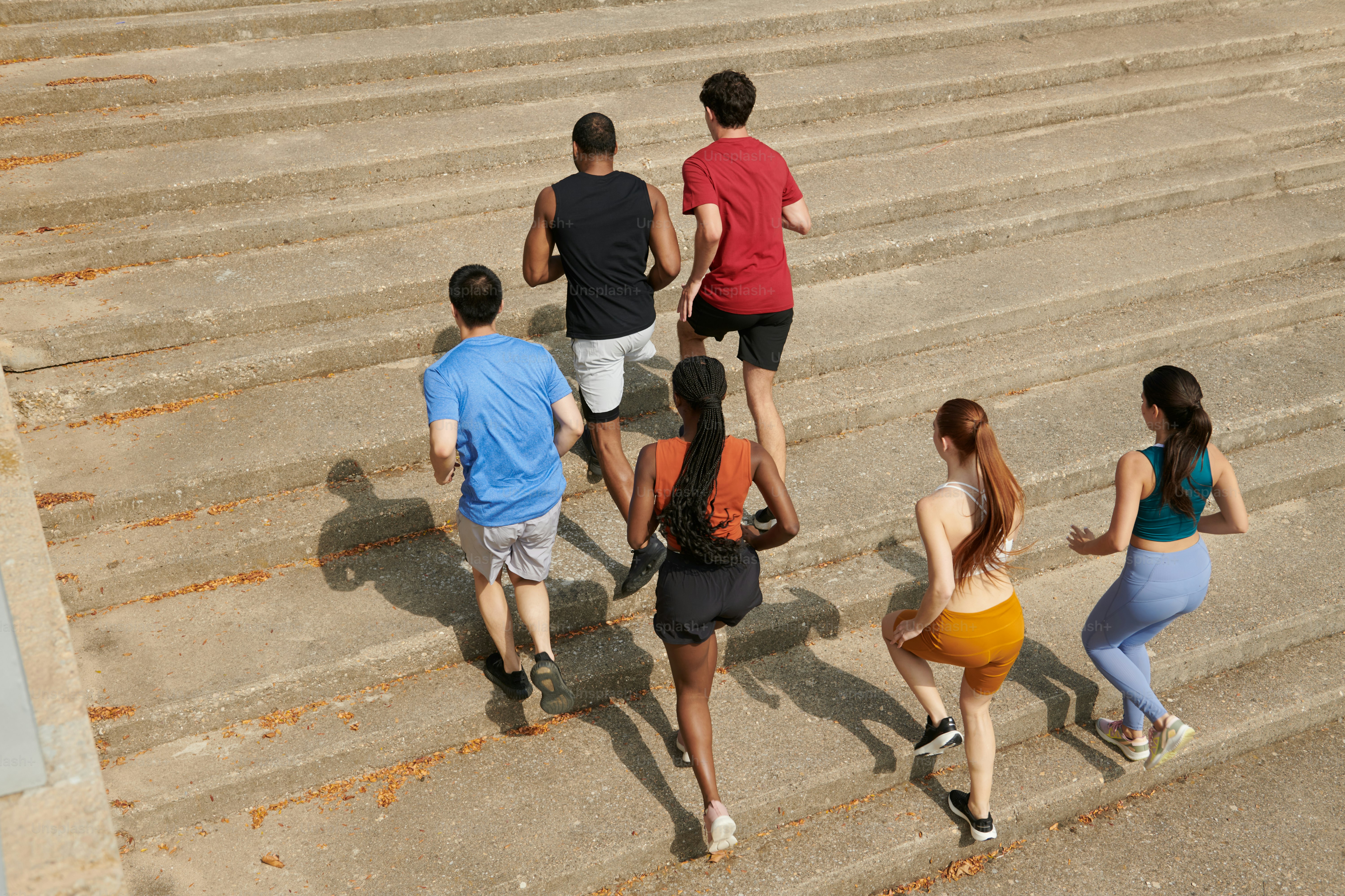 A group of people walking up some steps photo – Fitness Image on Unsplash