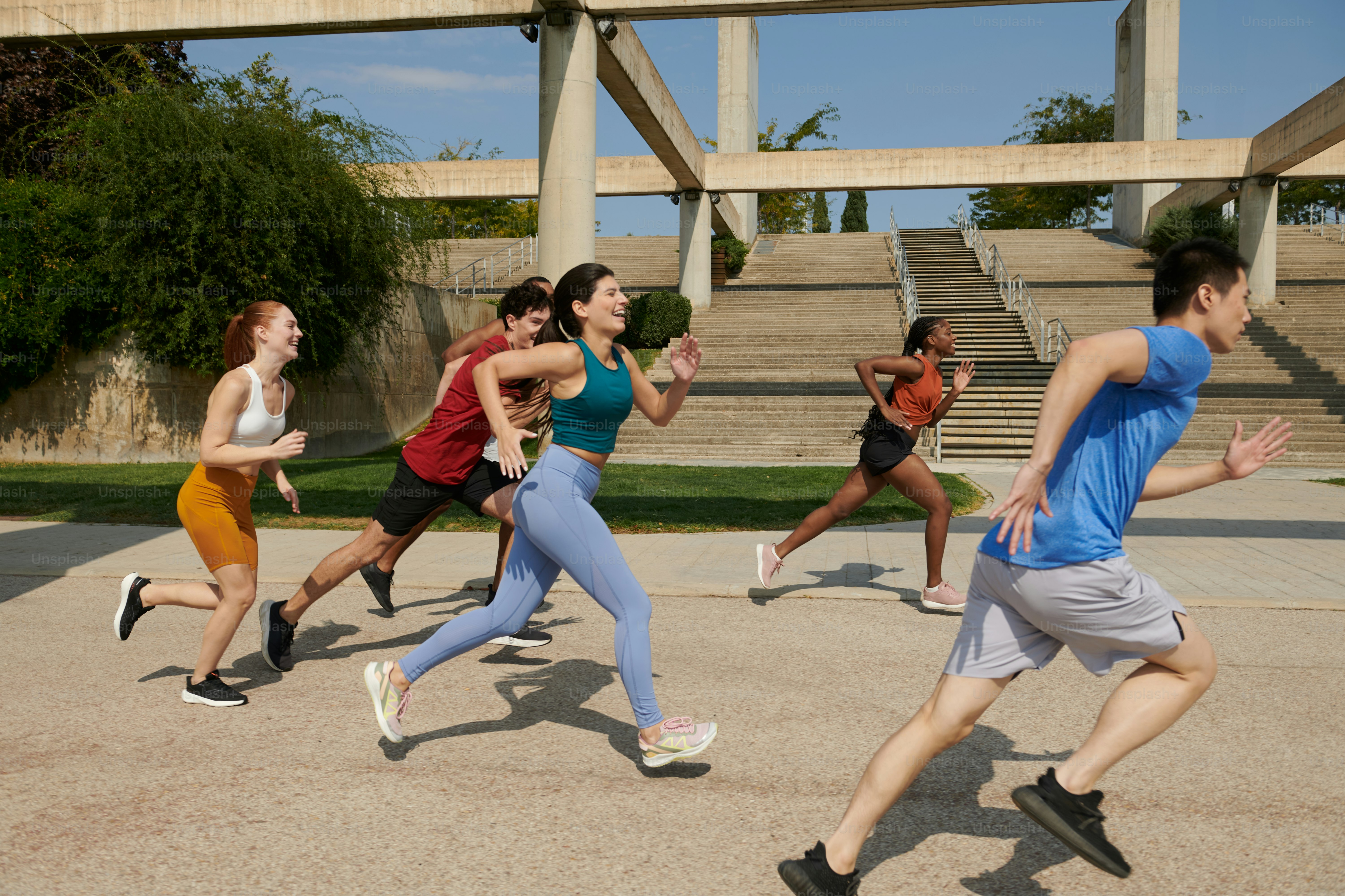 A group of people running in a parking lot photo – Run club Image on ...