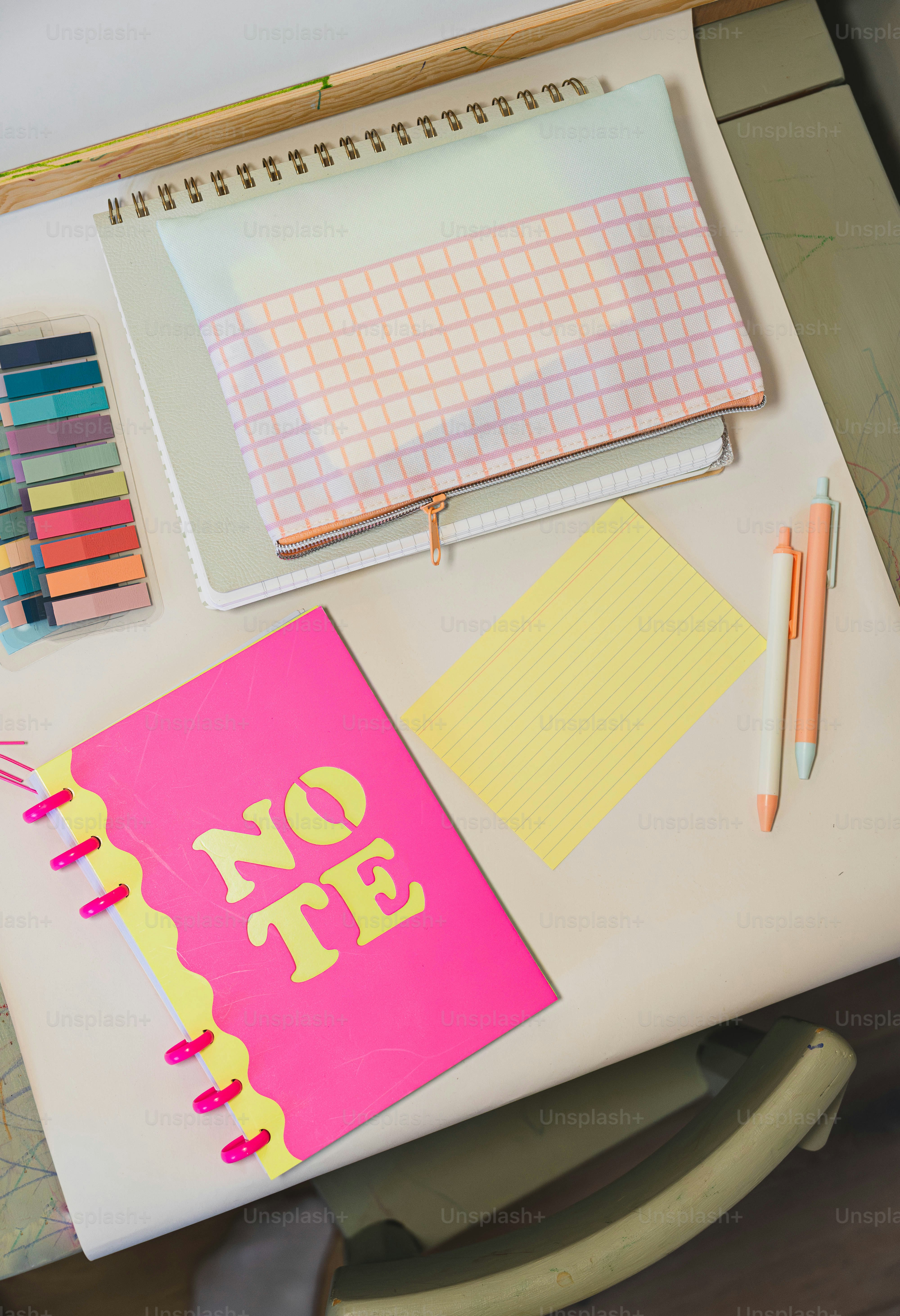 A desk topped with lots of different types of paper photo – Notebook ...