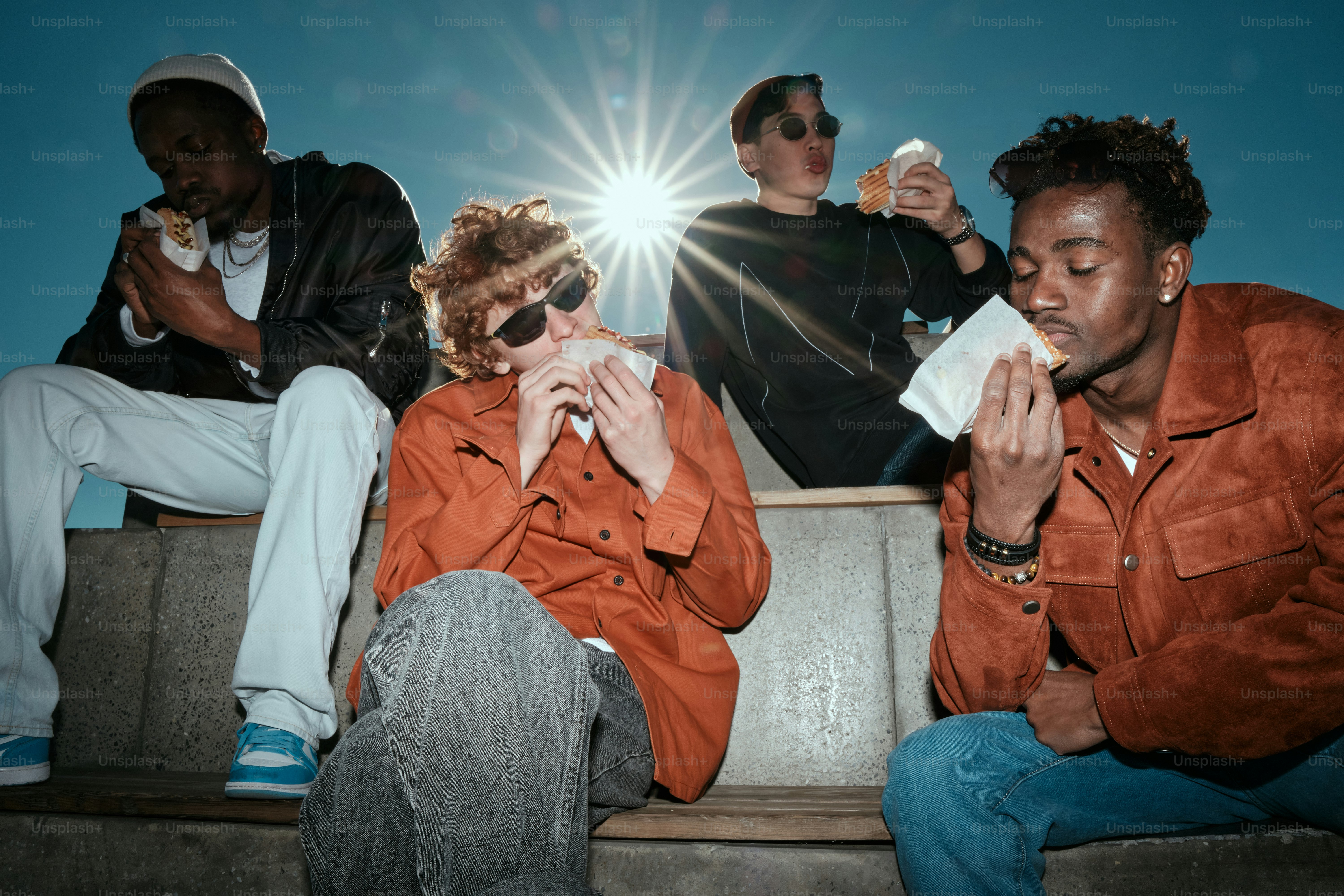 A group of people sitting on top of a bench photo – Friends Image on ...