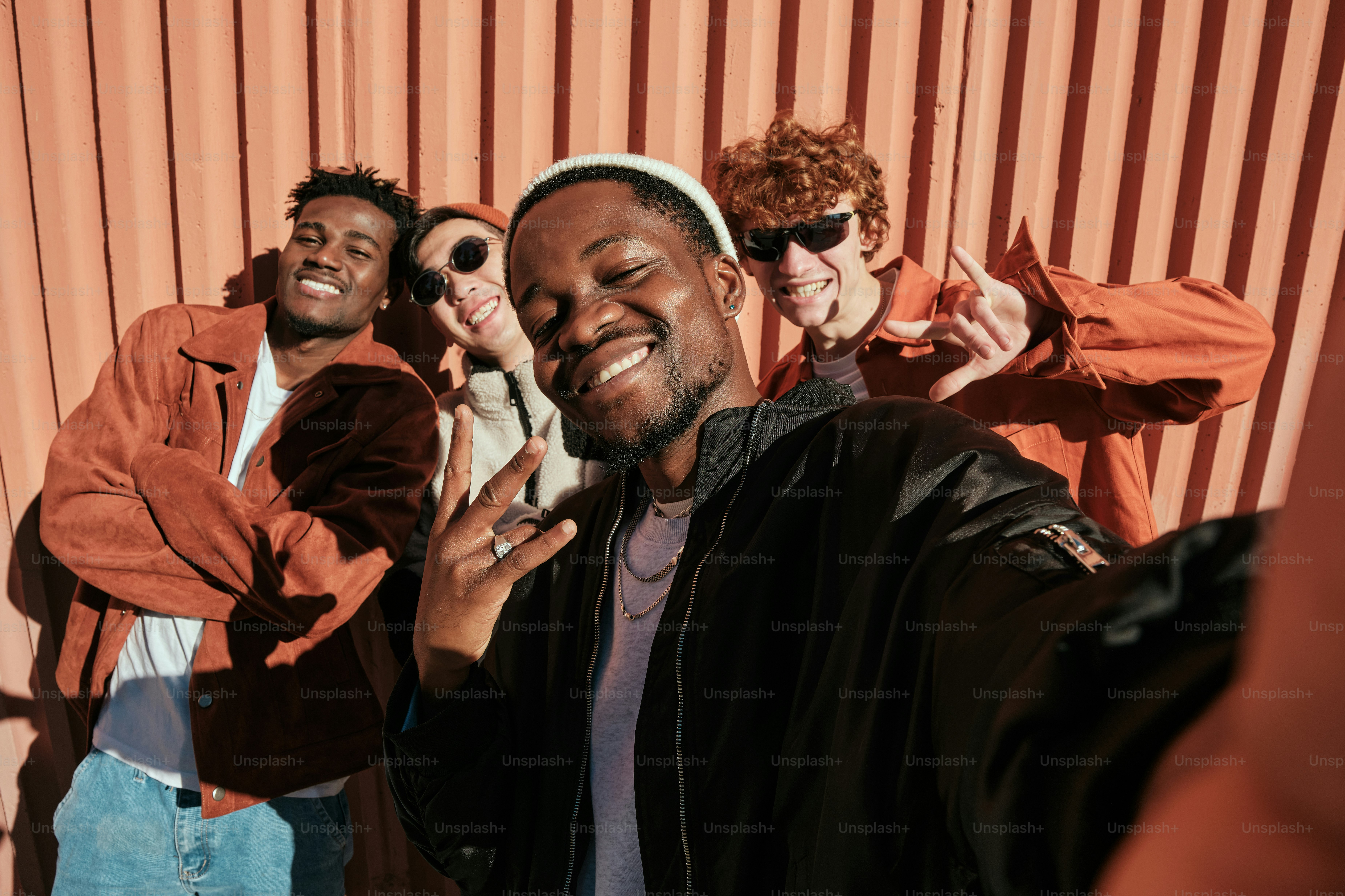 A group of young men standing next to each other photo – Friends Image ...