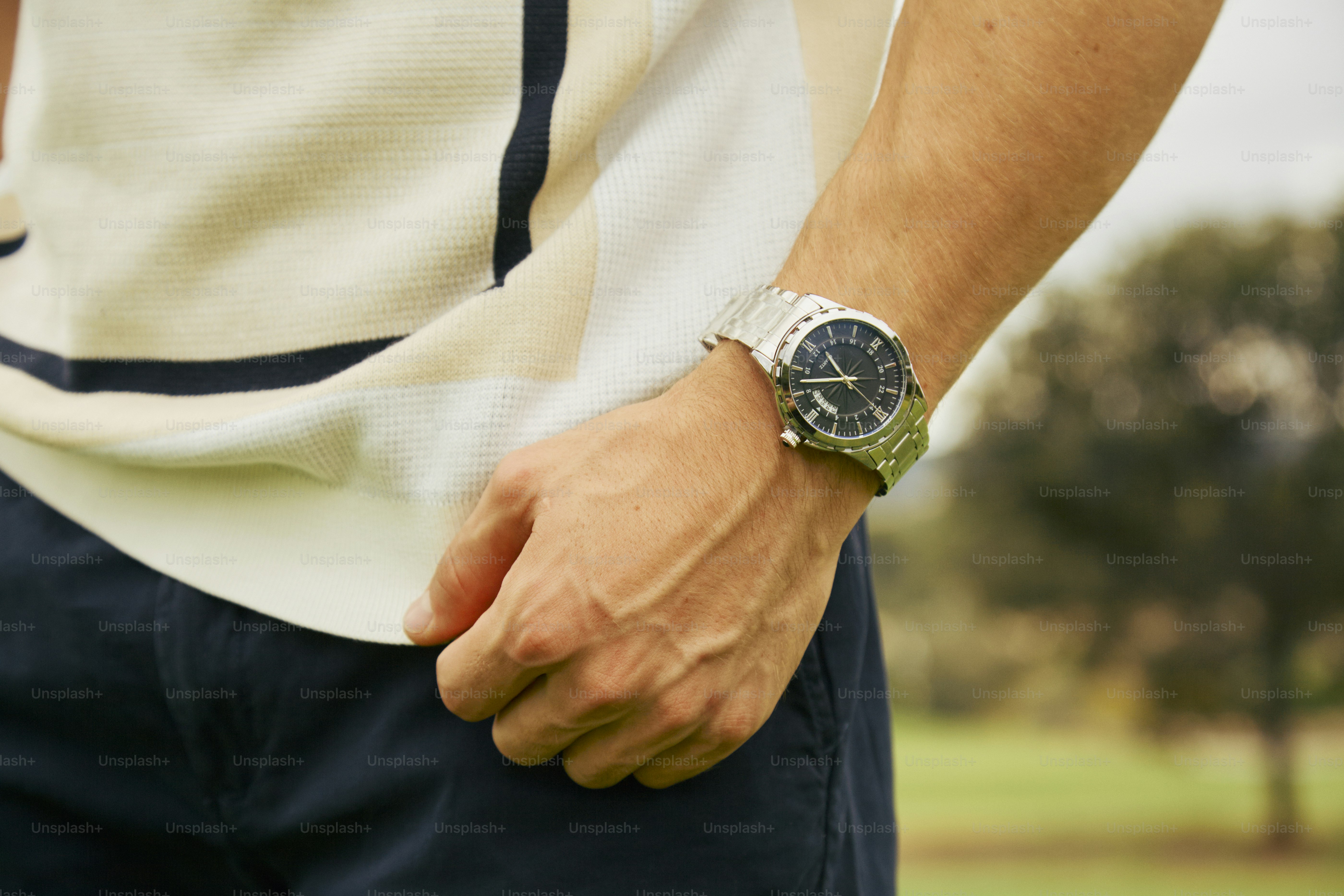 A close up of a person wearing a watch photo – Portrait Image on Unsplash