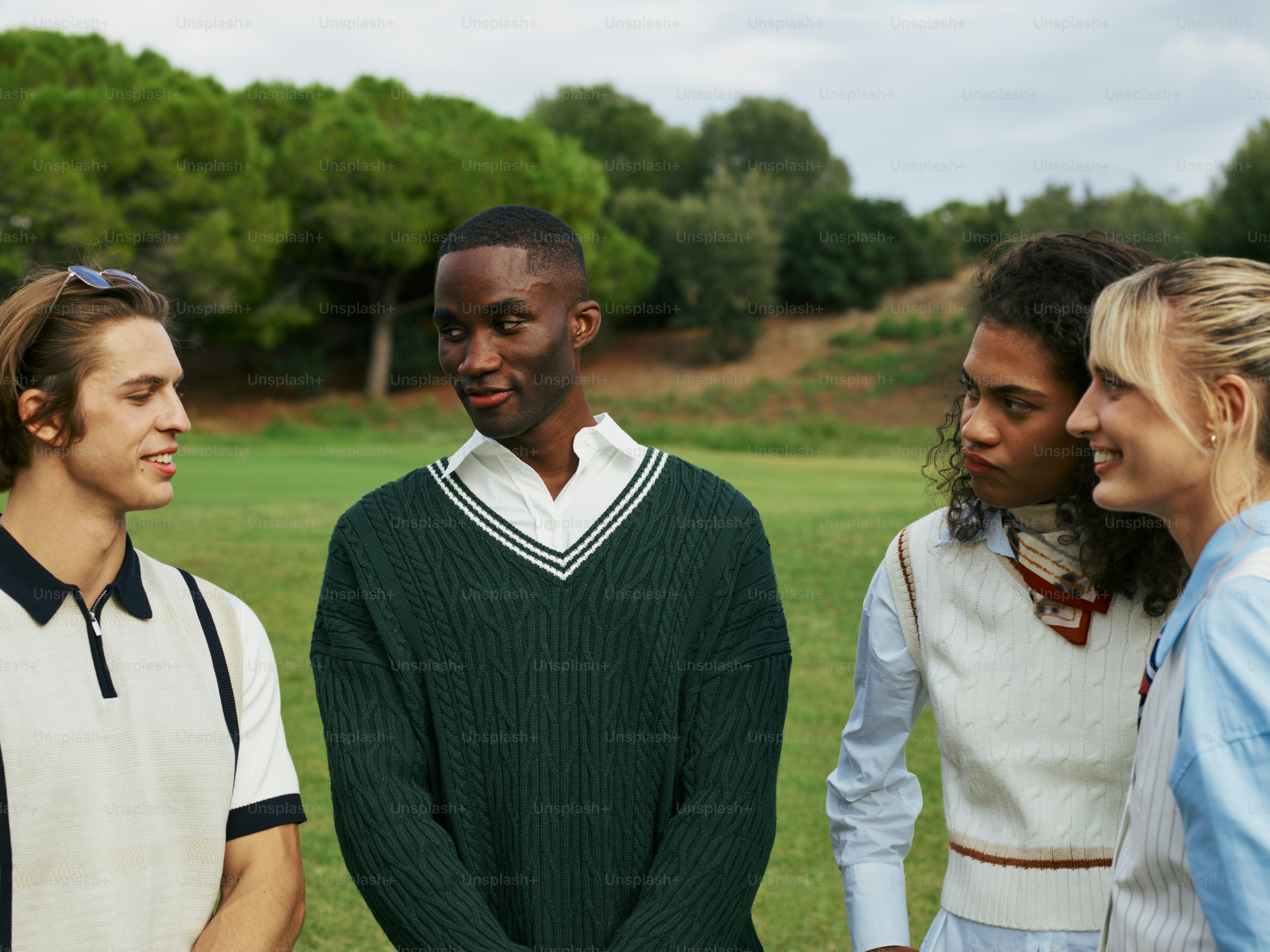 A group of people standing around each other photo – Style Image on ...