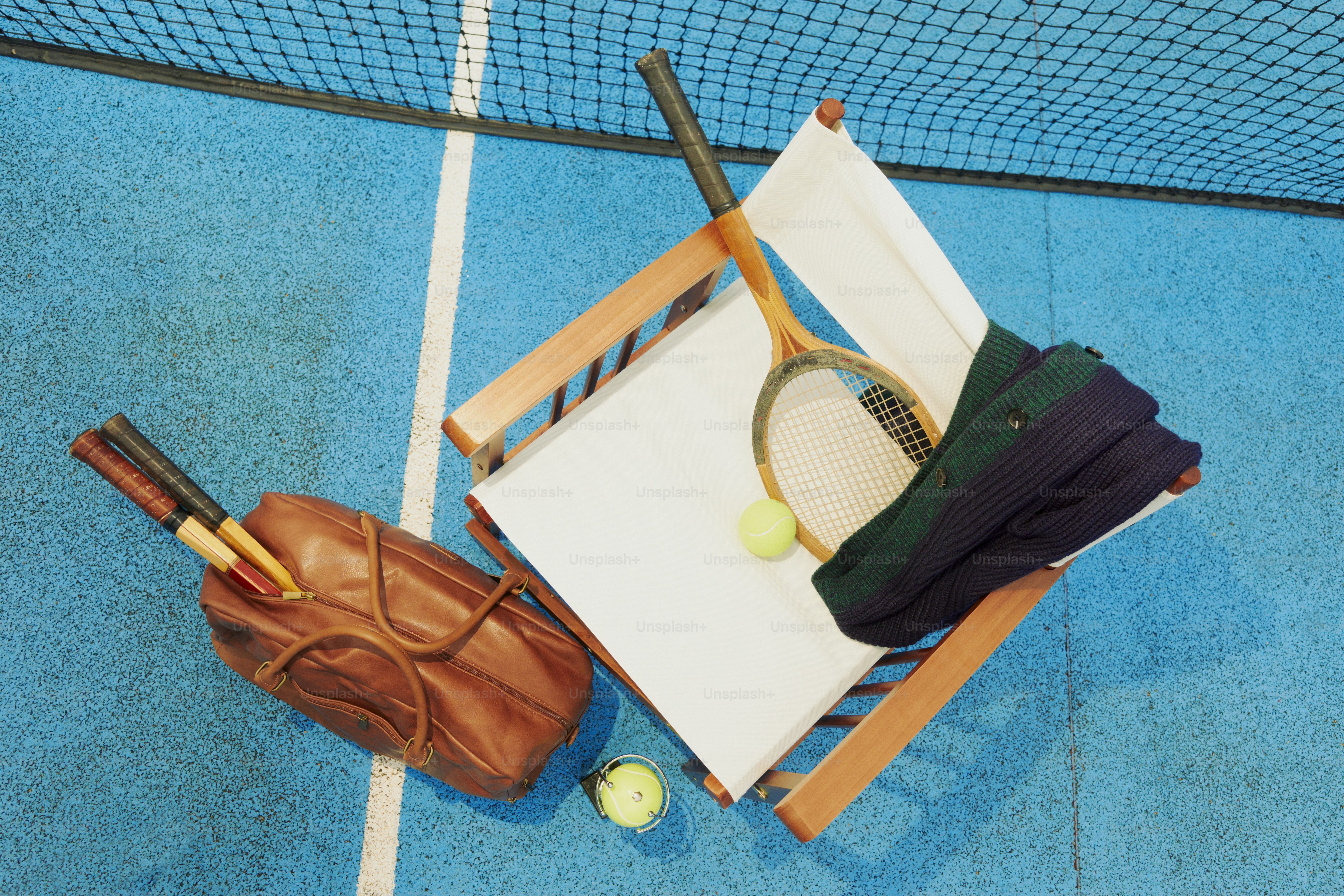 A tennis court with a chair and a racket photo – Fashion Image on Unsplash