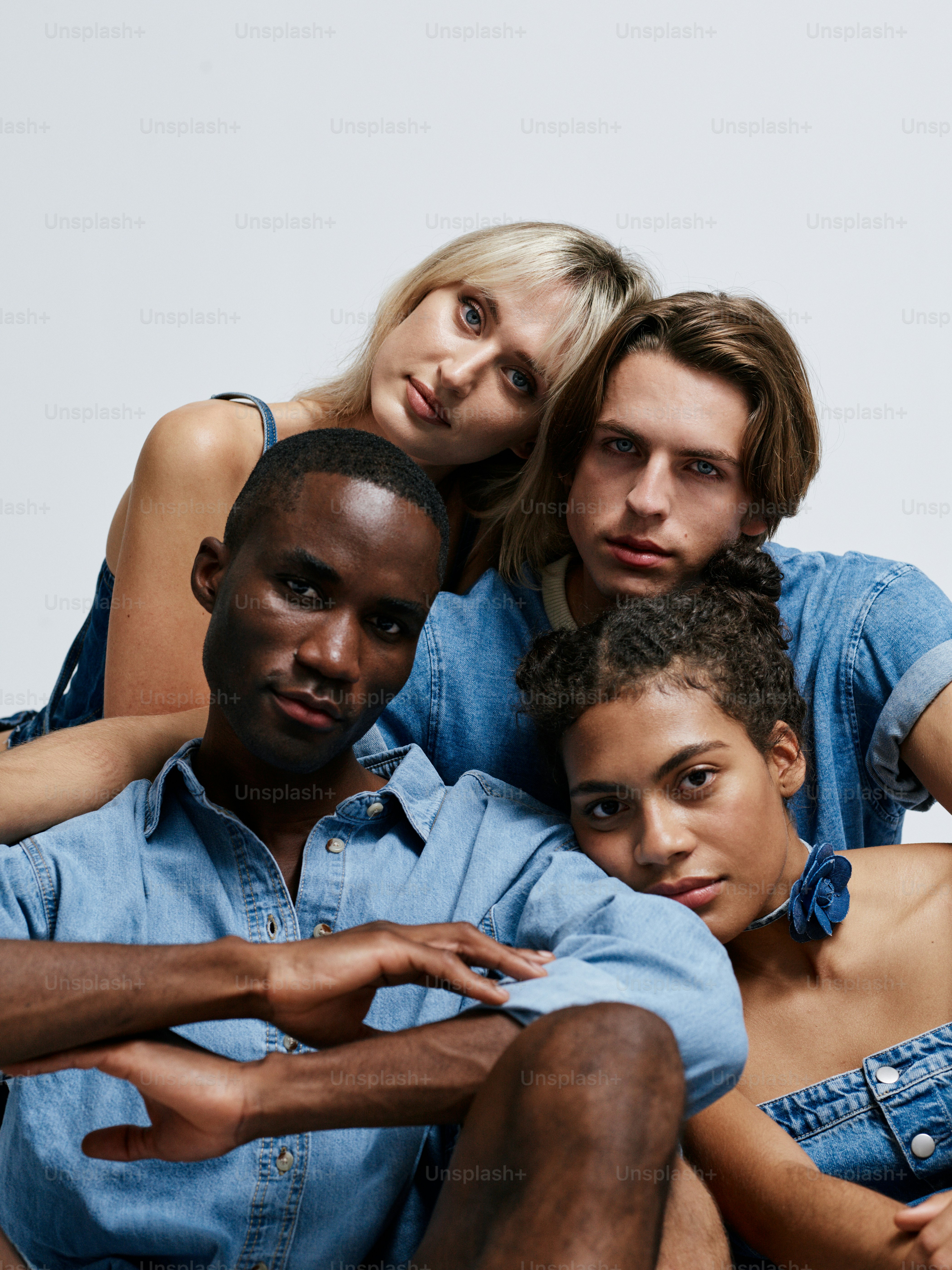 A group of people sitting next to each other photo – Studio Image on ...